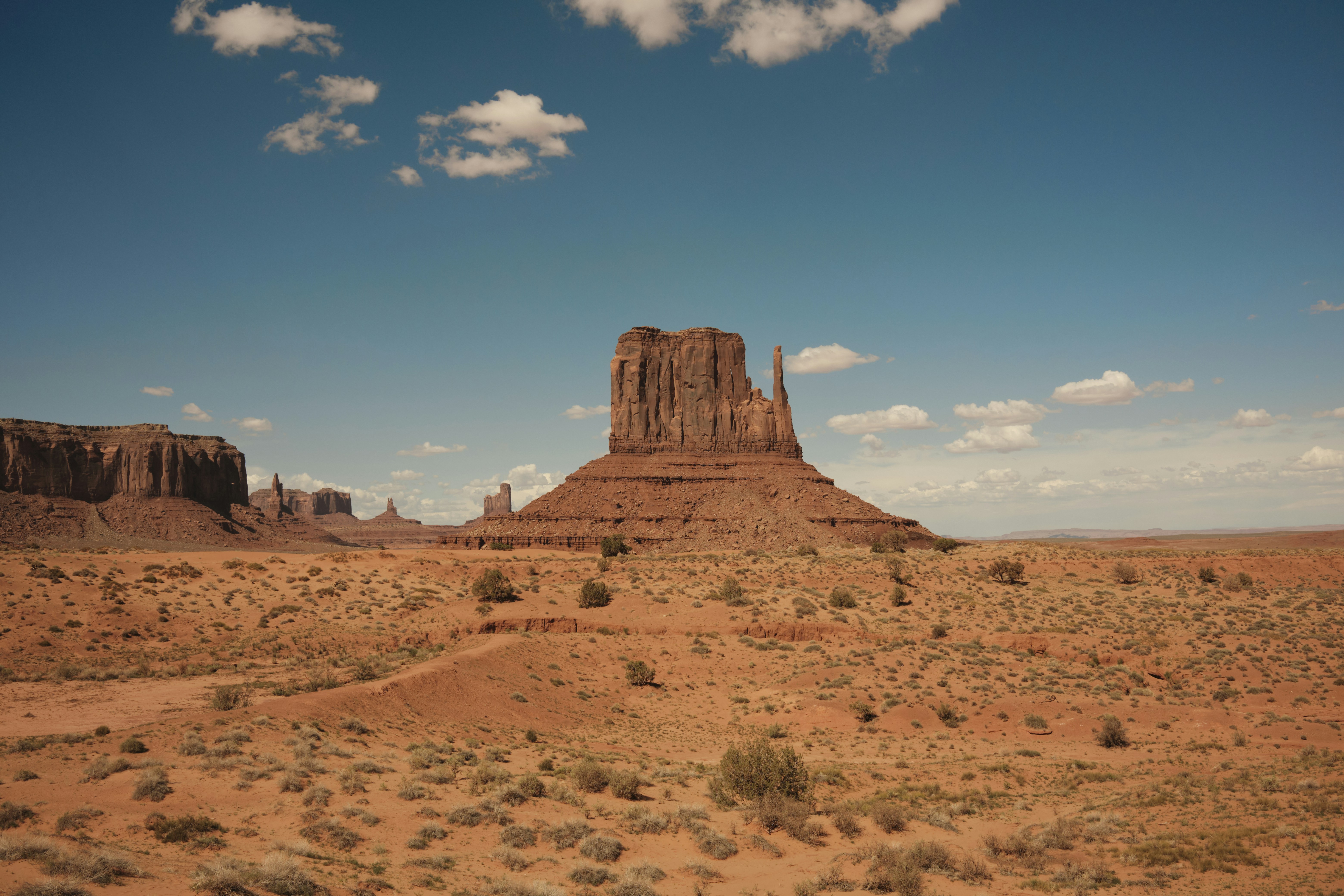 A desert landscape with a few large rock structures photo – Free ...