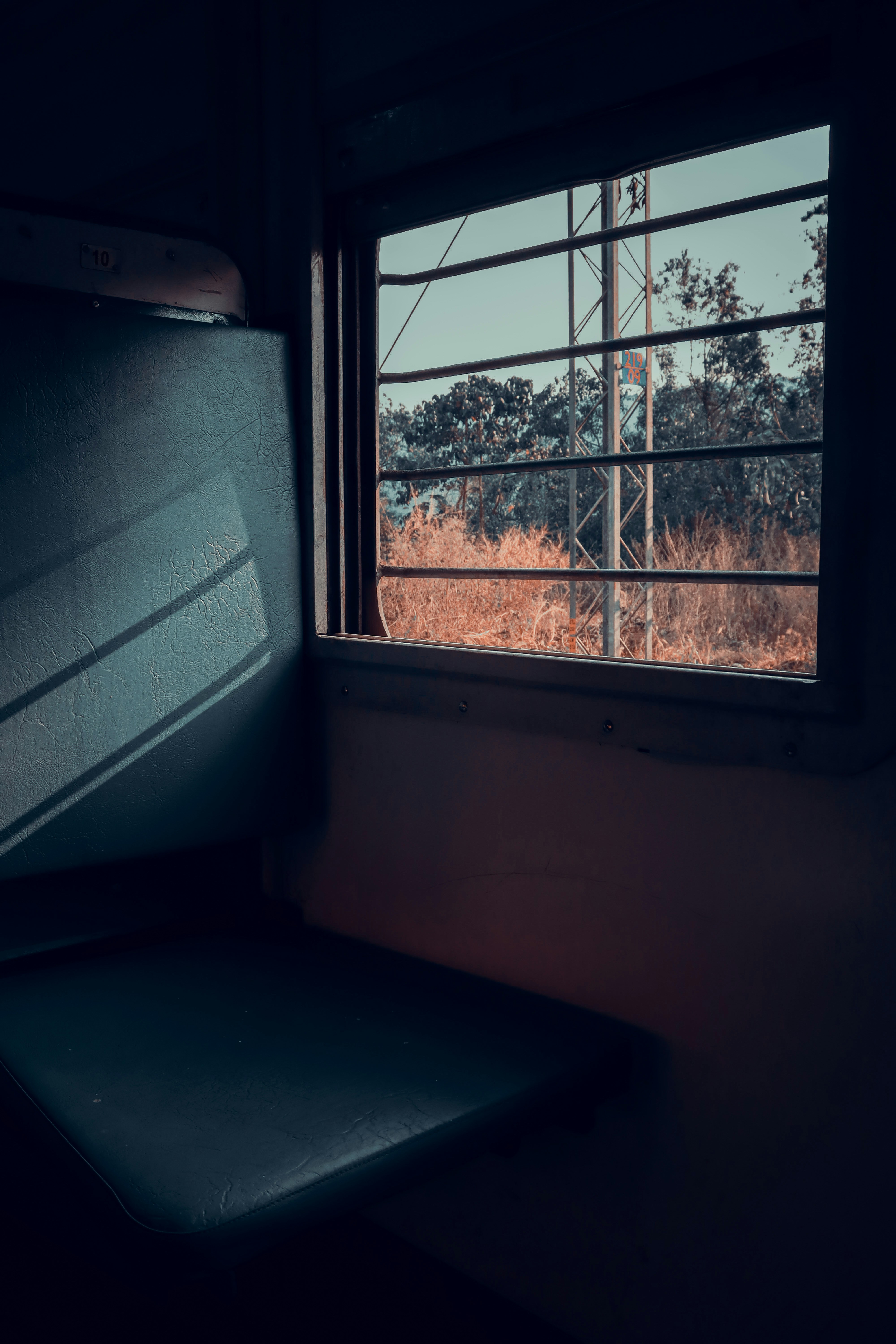 Latticed Window, Orange Field: A Quiet Transit Moment