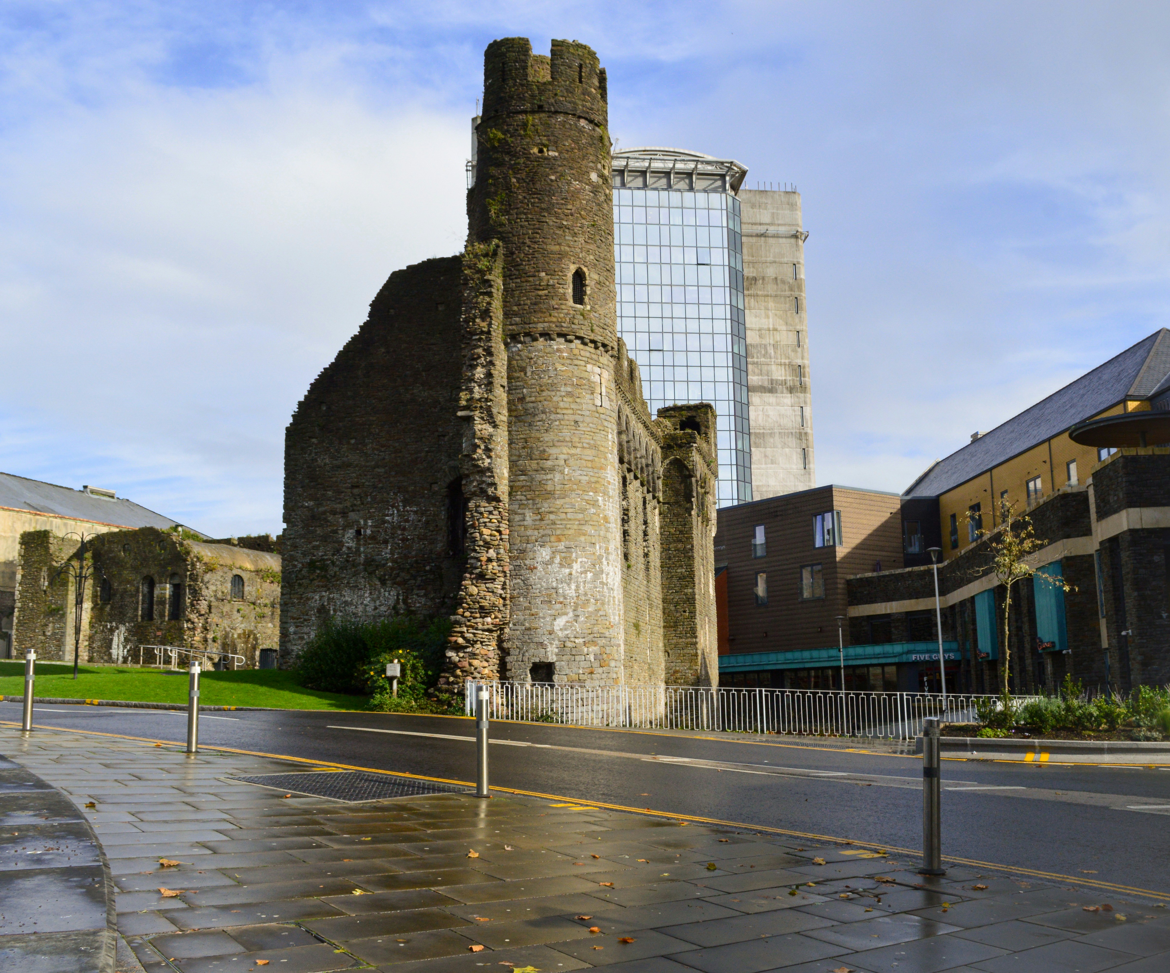 A stone castle with a fence around it photo – Free Swansea Image on ...