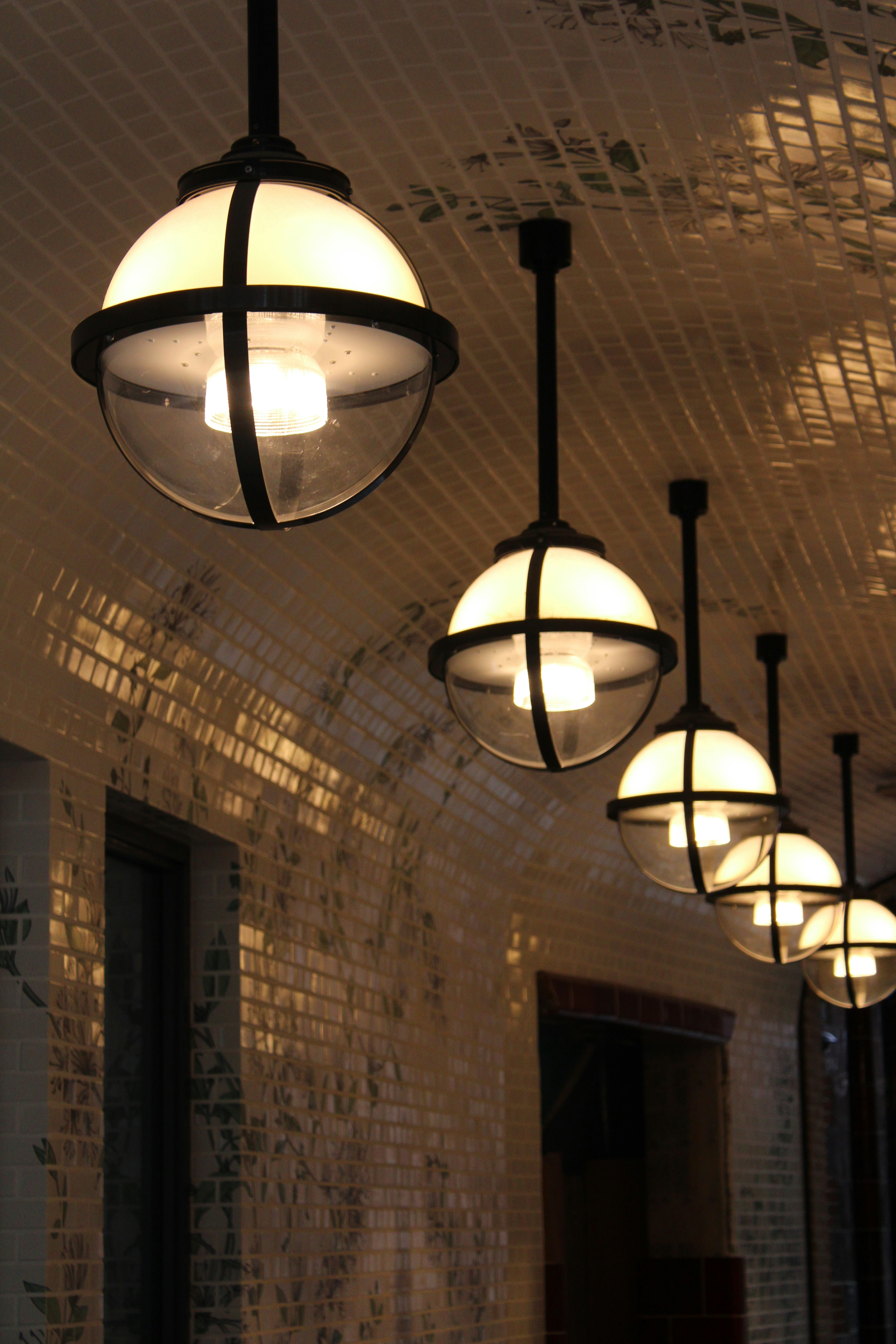 Row of Orb Lanterns: Warm Convergence Inside an Archway