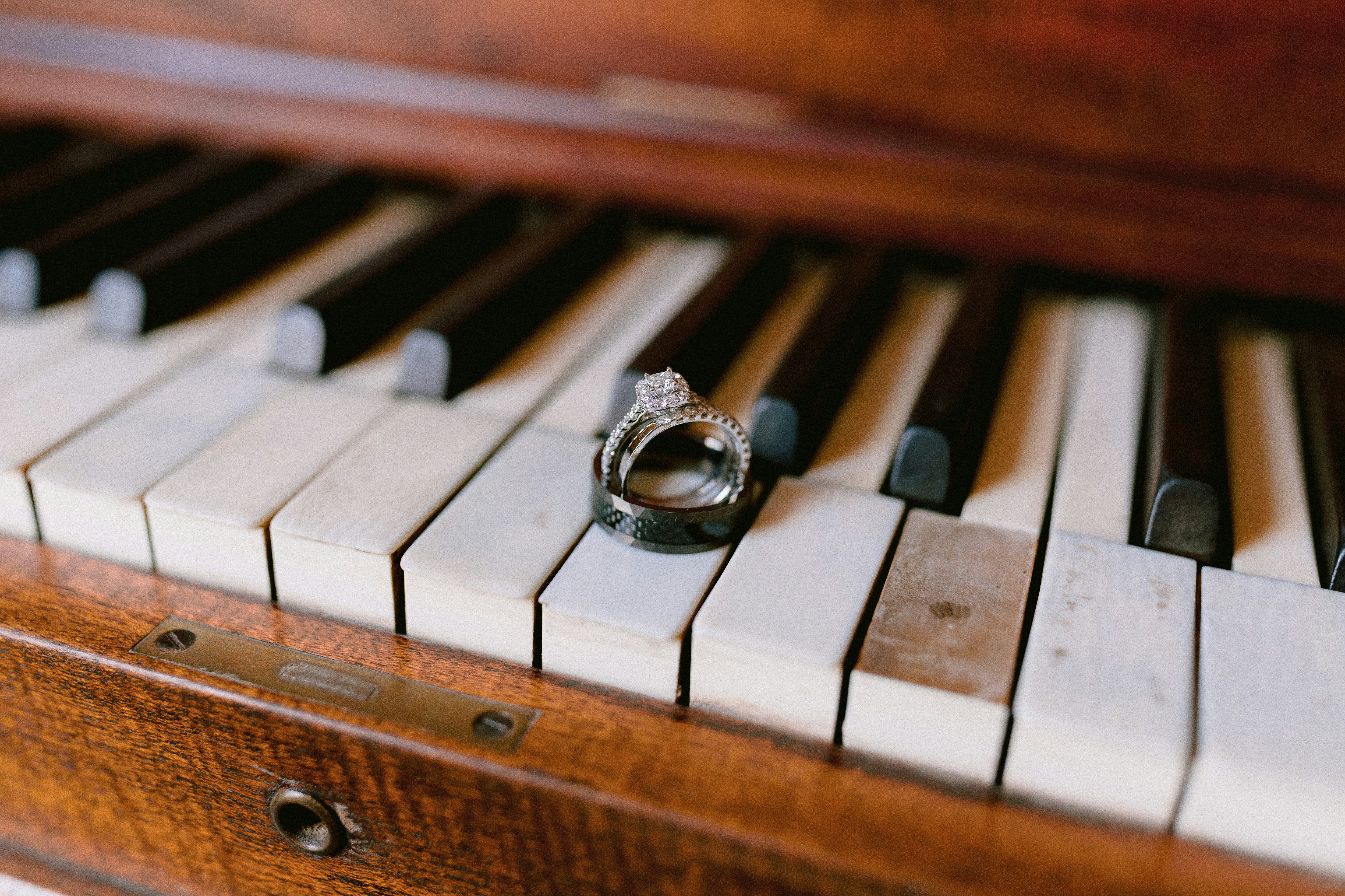 A wedding ring sitting on top of a piano photo – Free Piano Image on ...