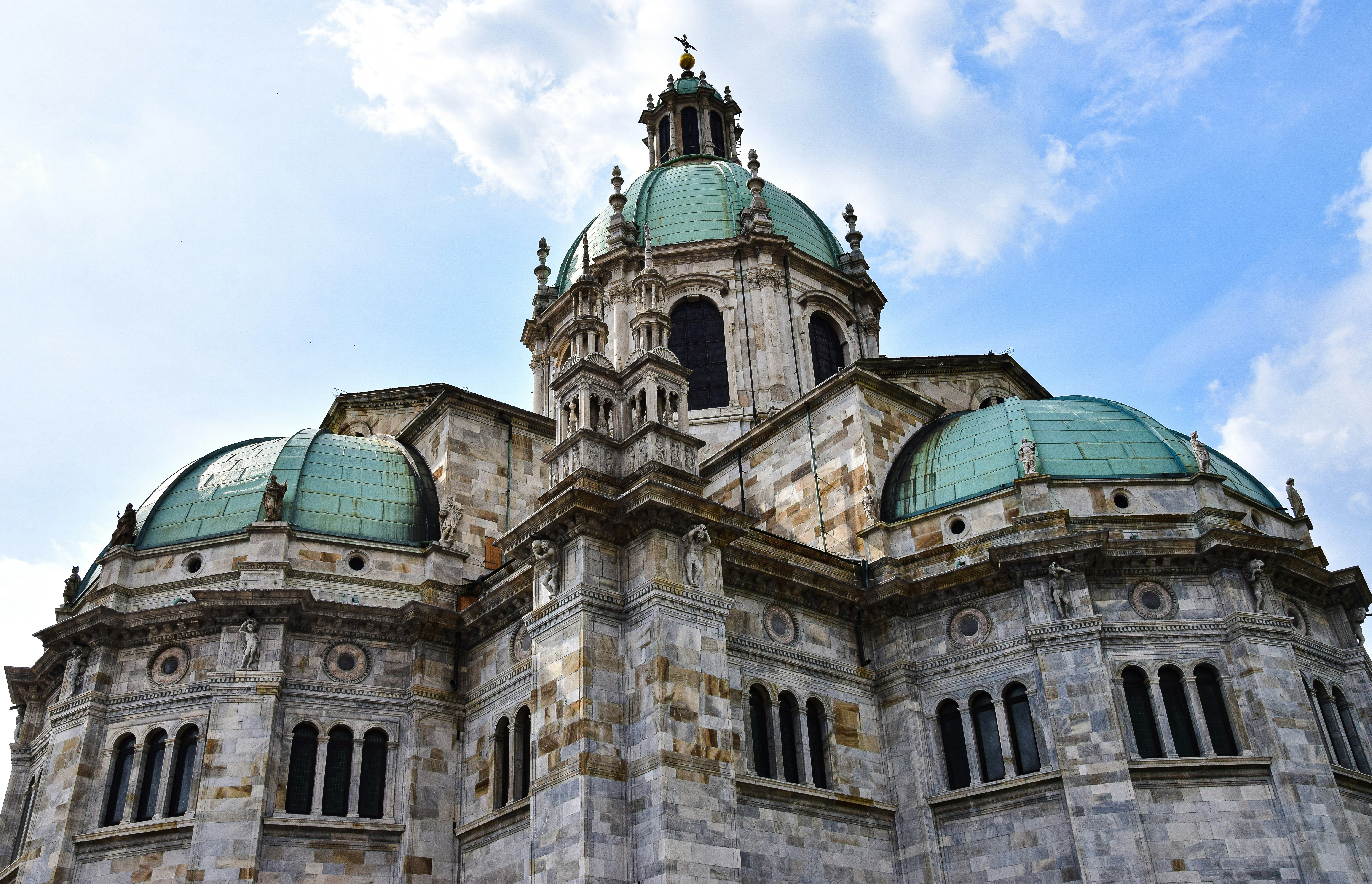 A large stone building with green domes photo – Free Italy Image on ...