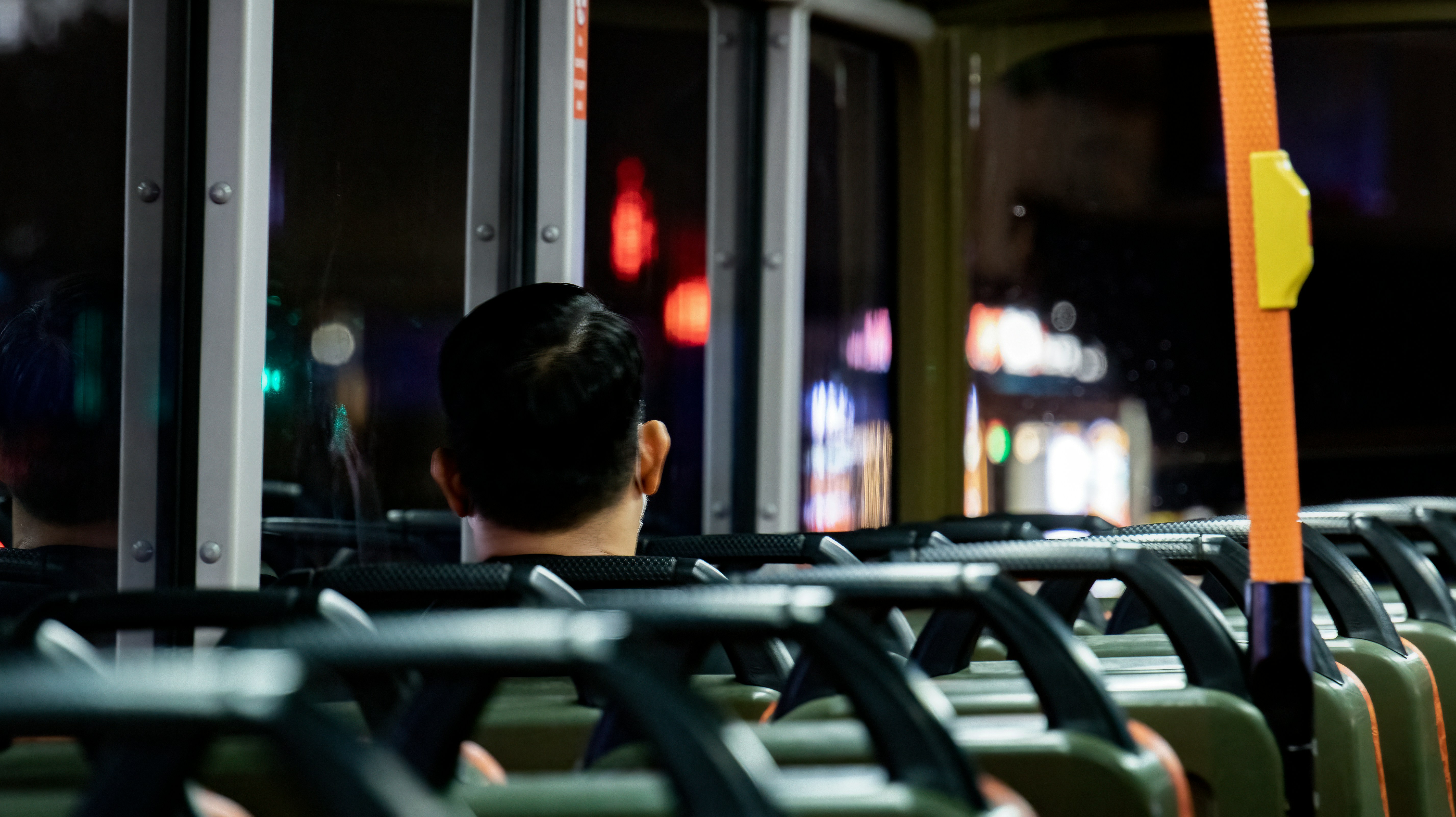 Back Seat Residency: Neon City Reflections on a Bus at Night