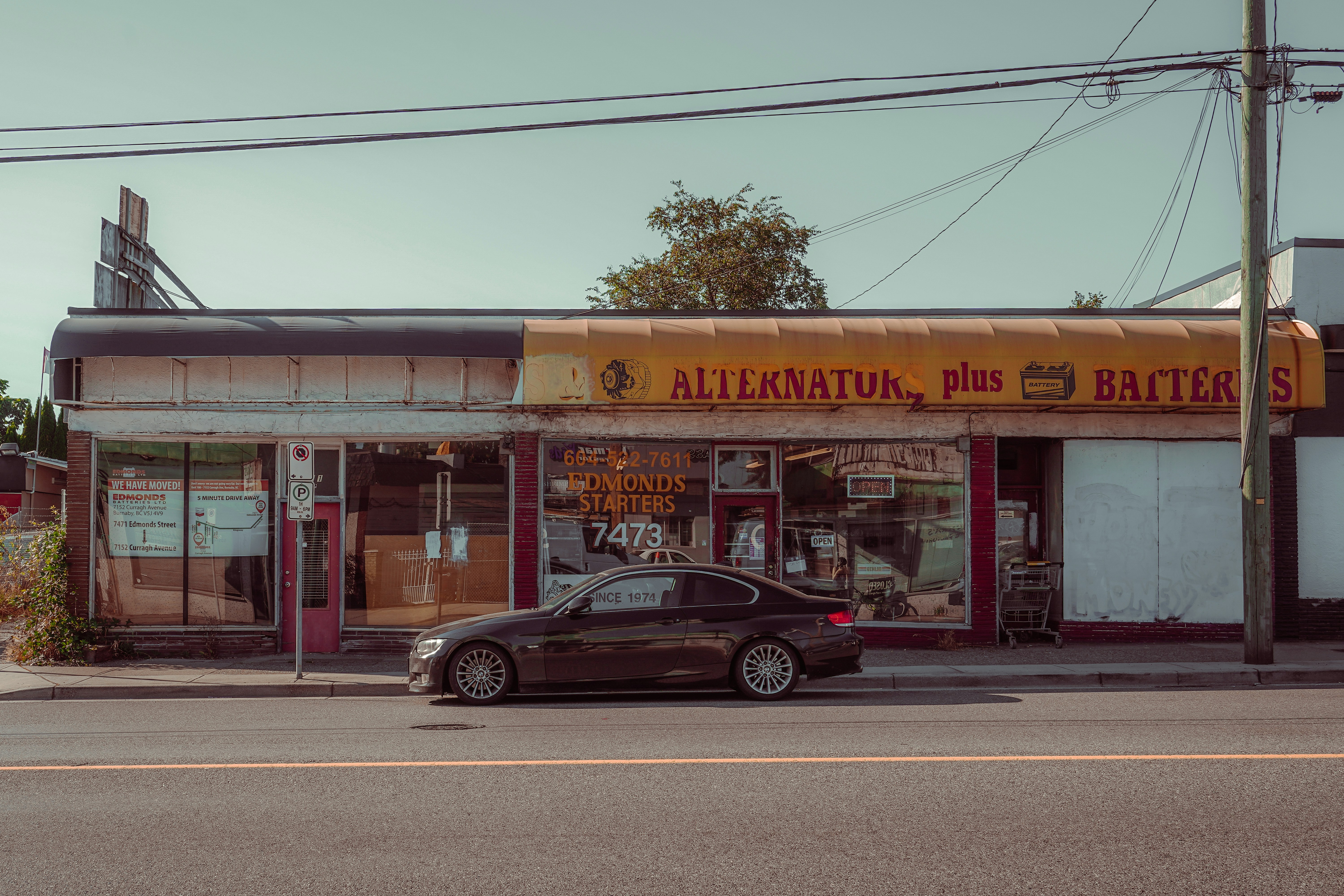 A car parked outside a store photo – Free Rundown building Image on ...