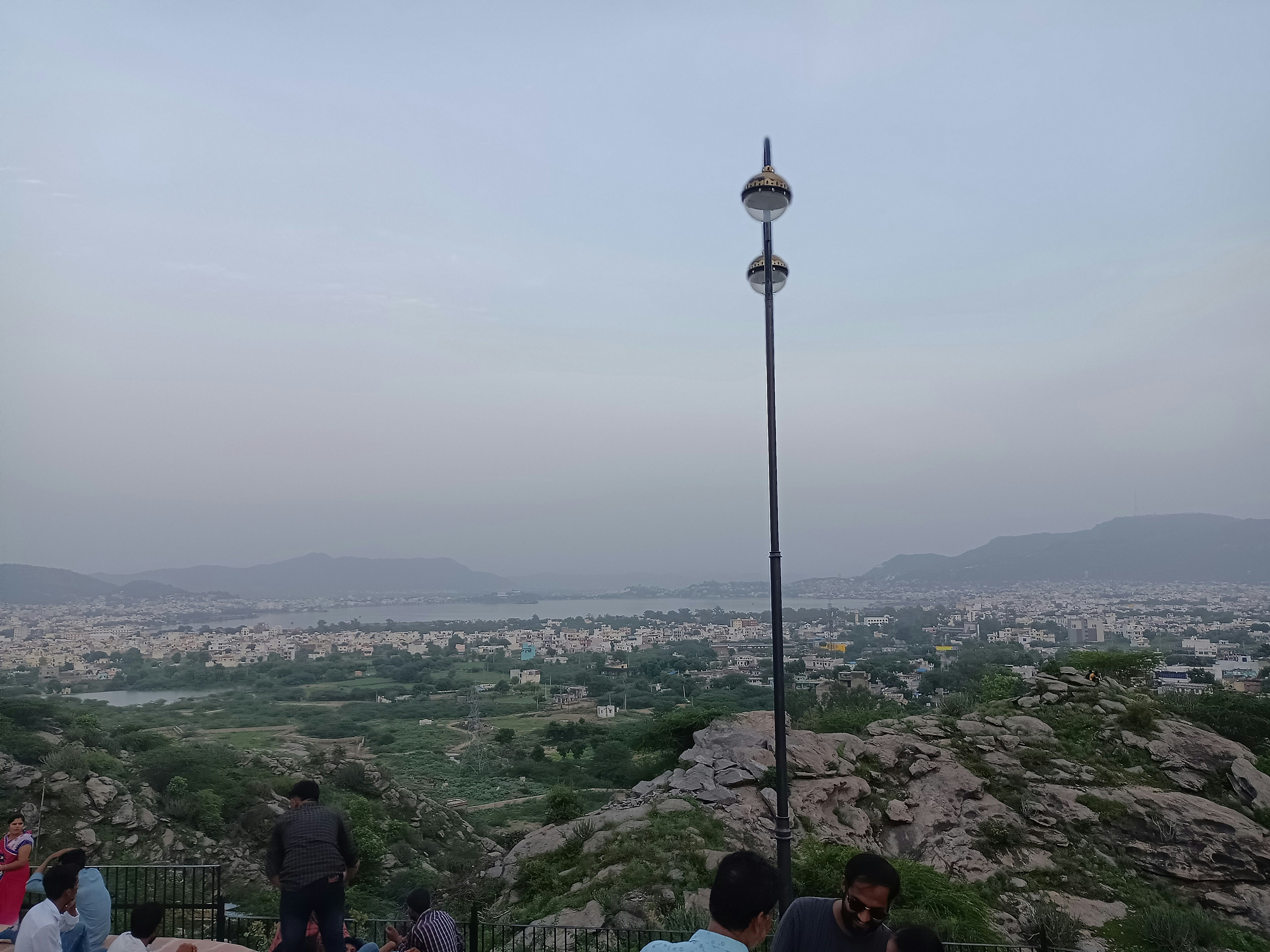 a tall light post on a hill