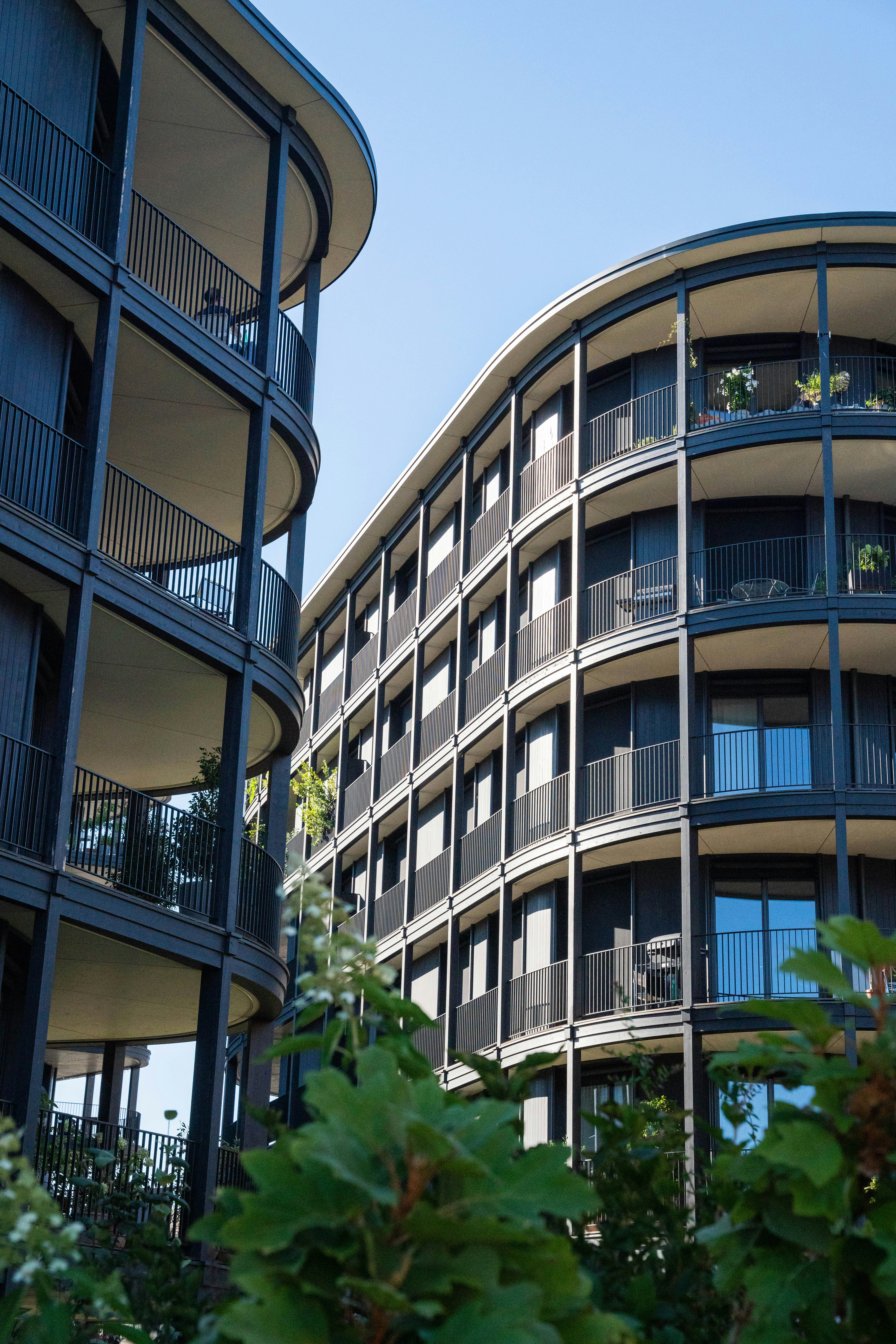 Un edificio con balcones y plantas frente a él foto – Imagen de Basilea gratuita en Unsplash