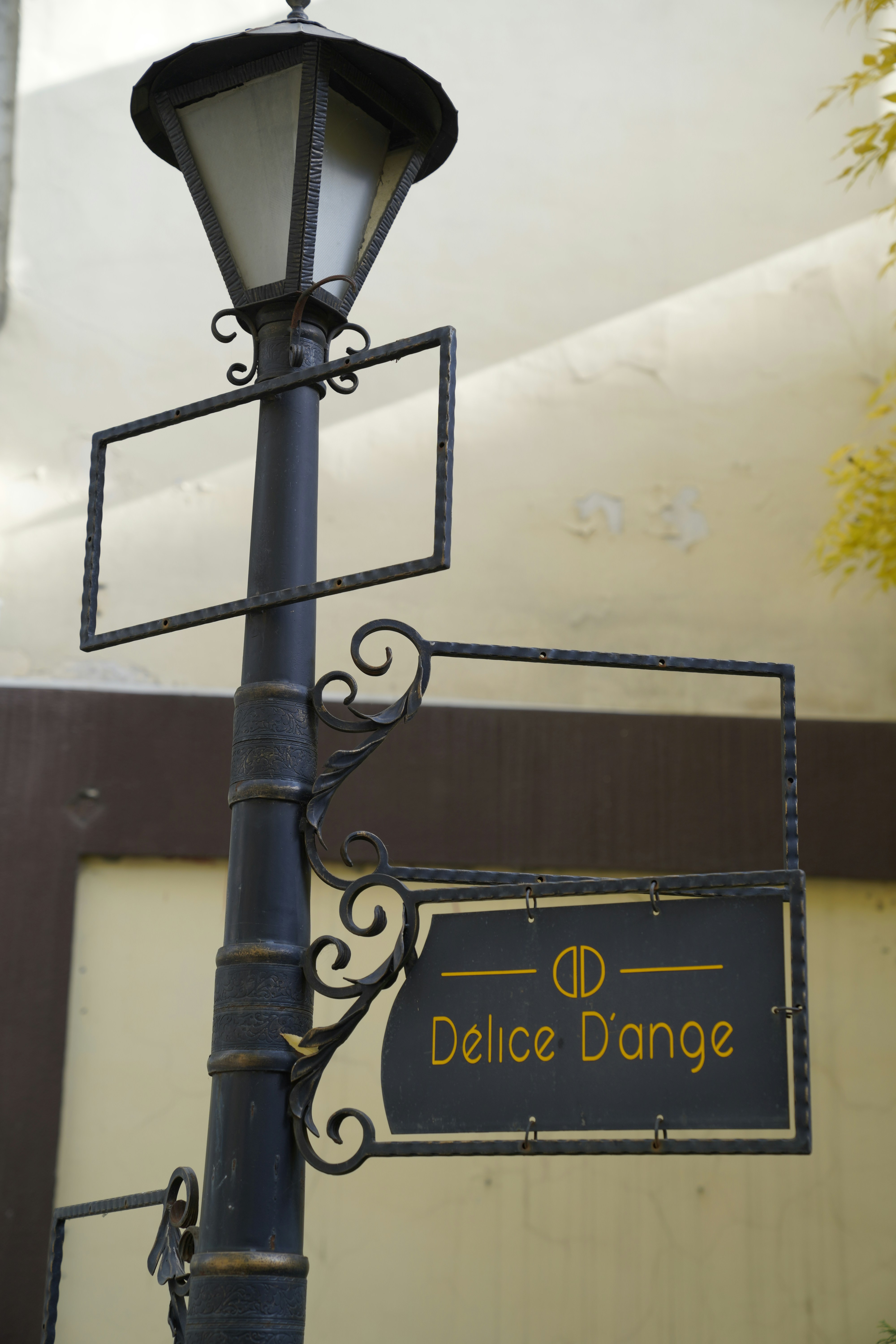Iron Lantern Framing Delice D'ange: A Quiet Vintage Street Sign