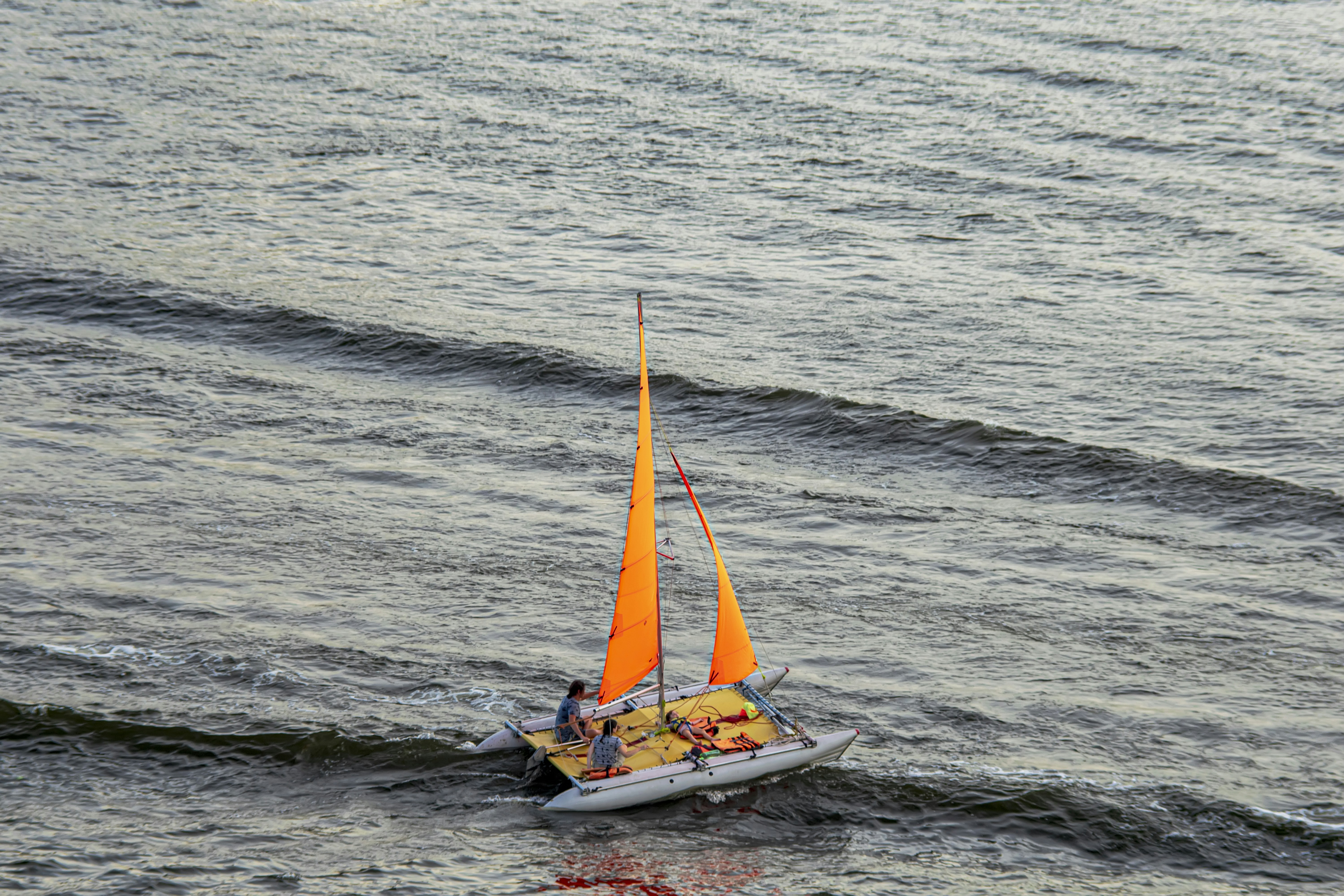 Amber Sails on Quiet Wake: A Tiny Boat Glides Across Sunlit Water