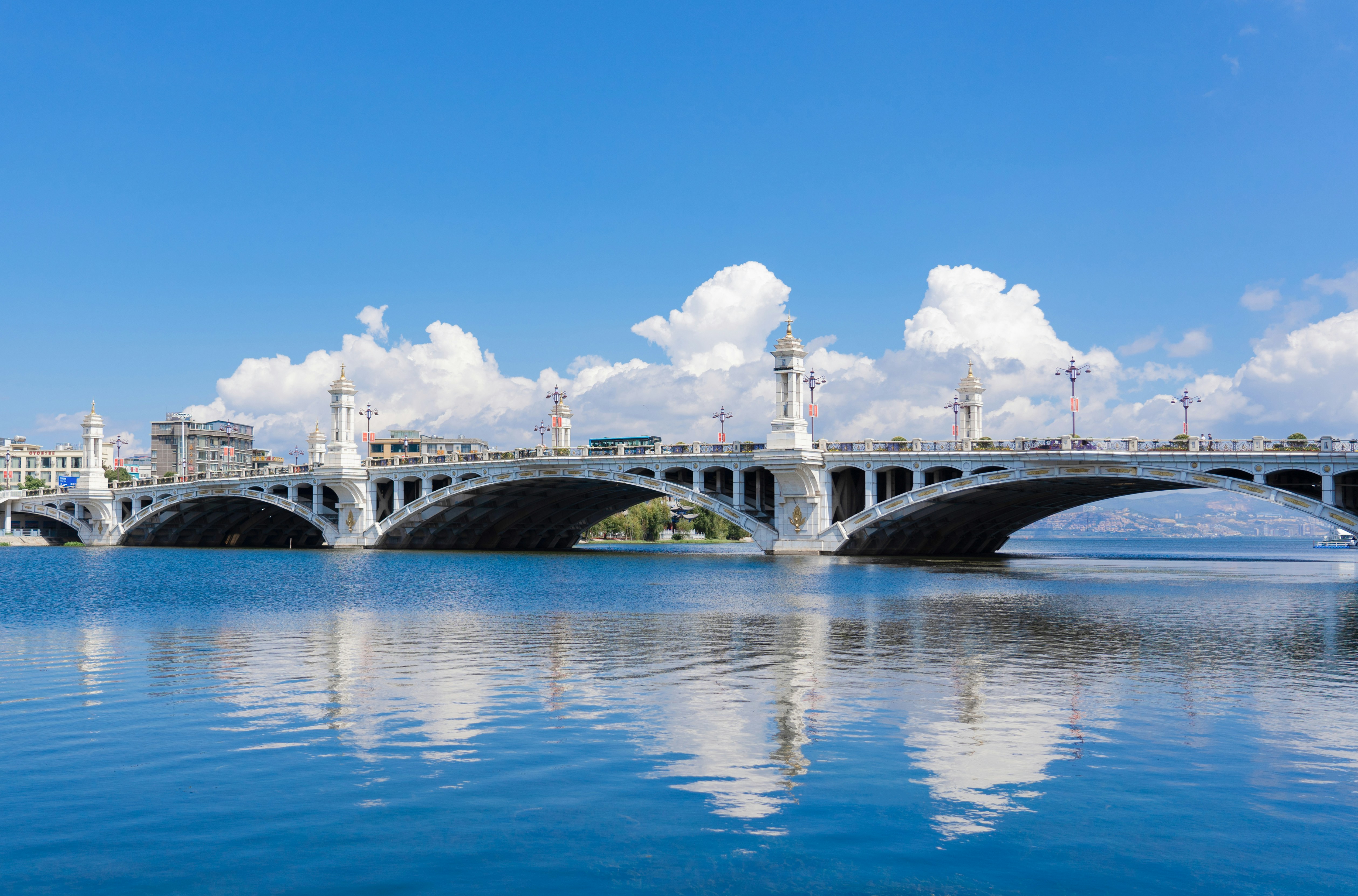 Three-Arch Bridge: Quiet River Reflections under a Bright Sky