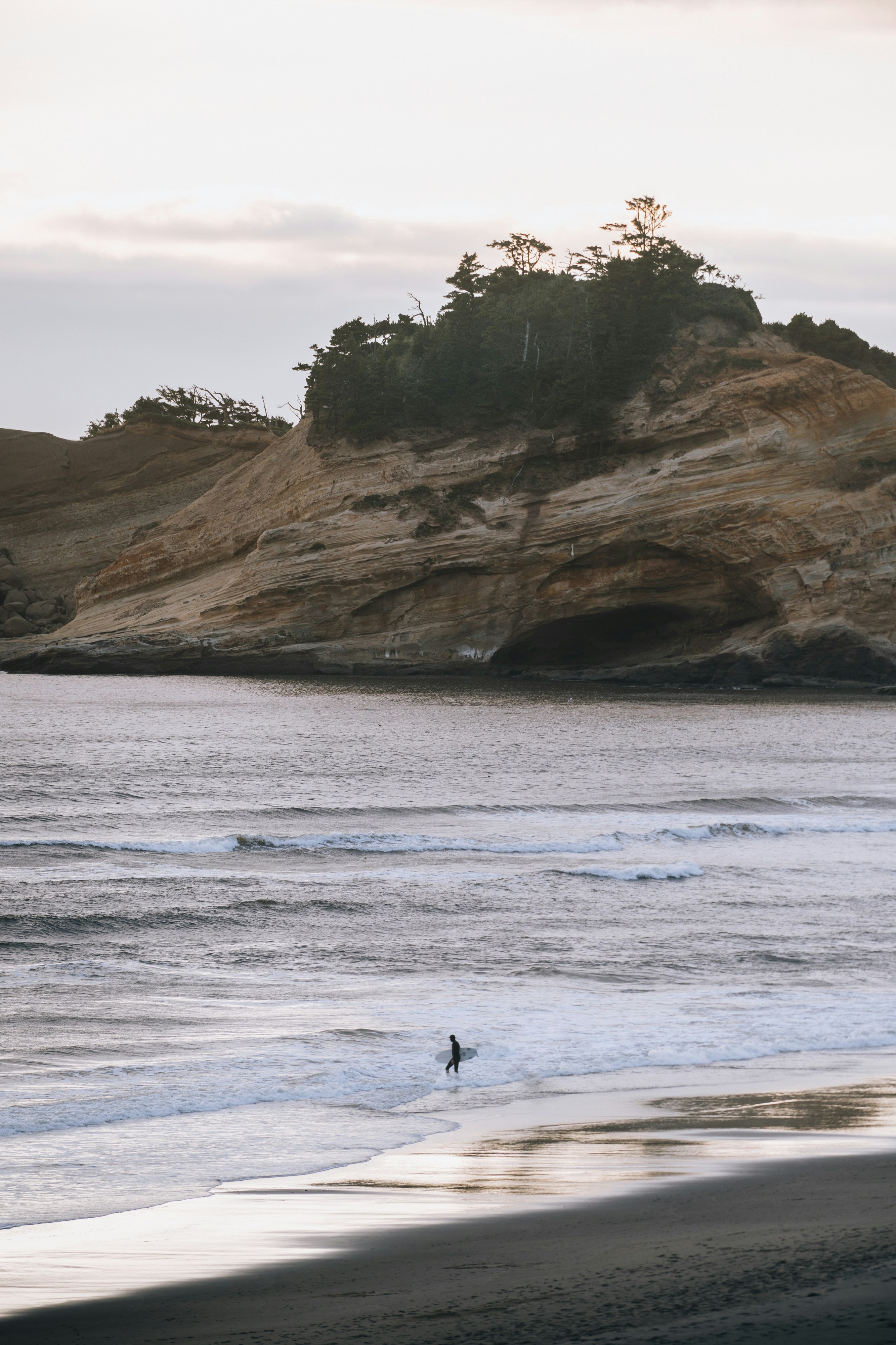 Solitary Surfer Near the Carved Cliffs