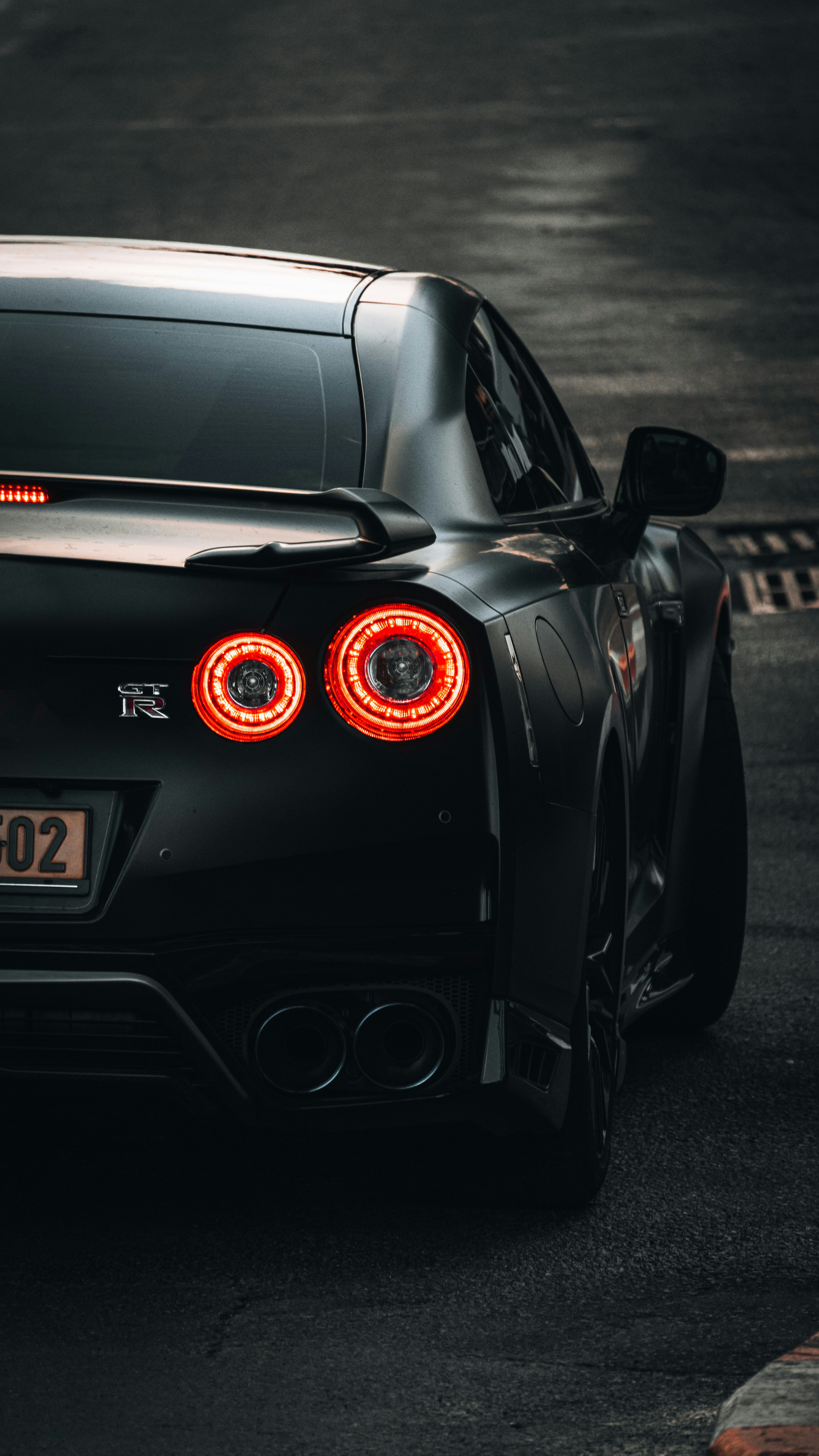 A black car with red lights photo – Free Sport car Image on Unsplash