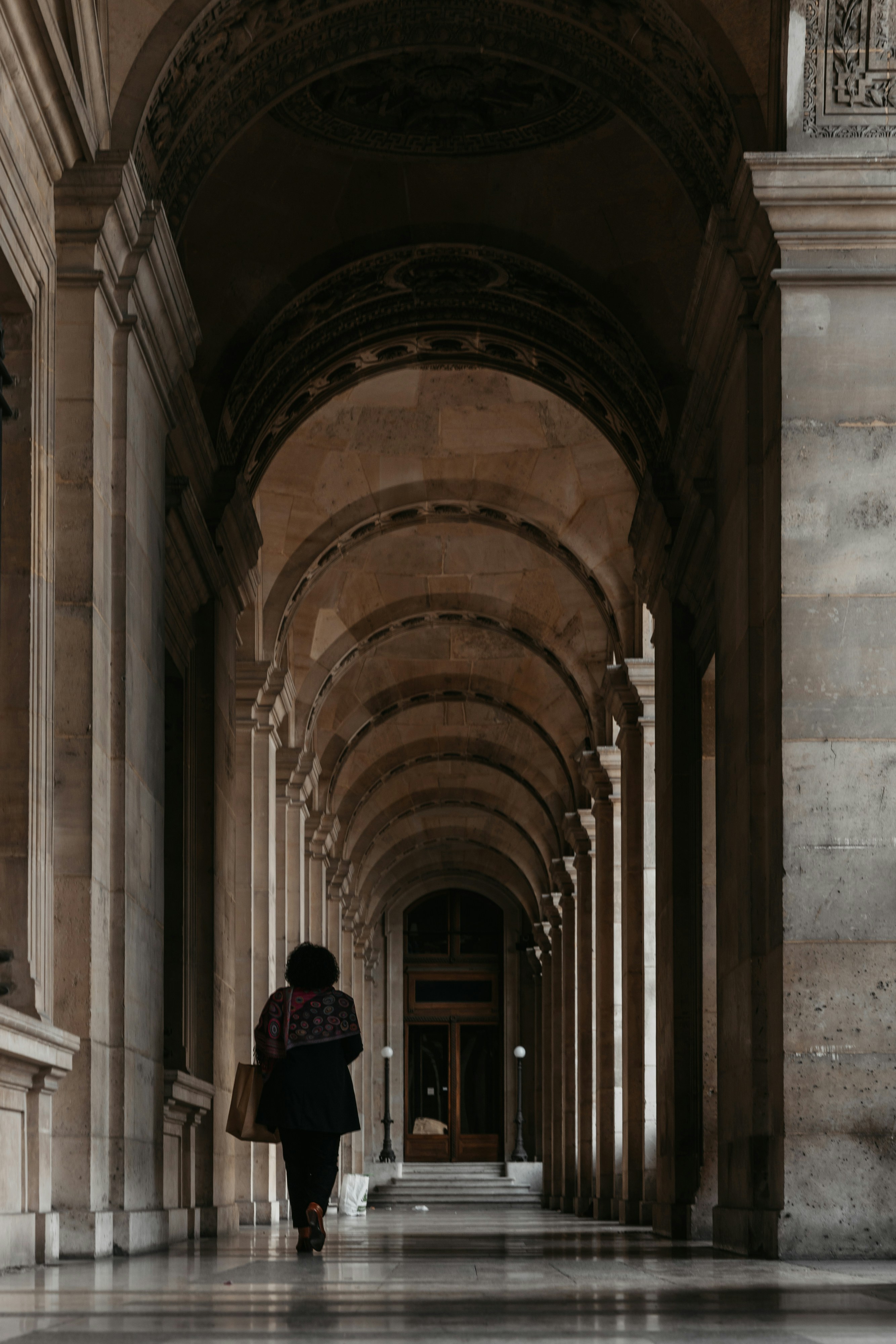 A person walking through a building photo – Free Corridor Image on Unsplash