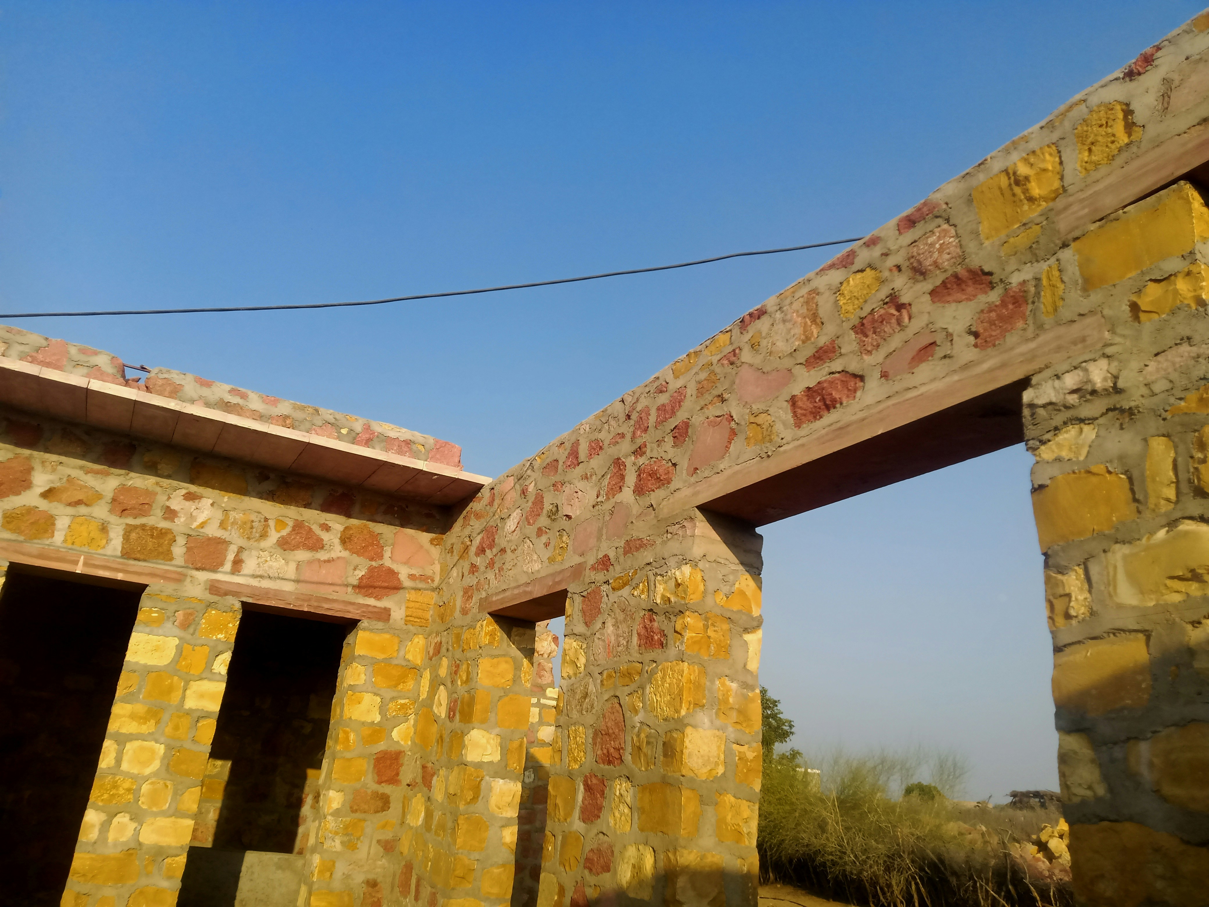 A stone building with a blue sky photo – Free Gadra road barmer Image ...