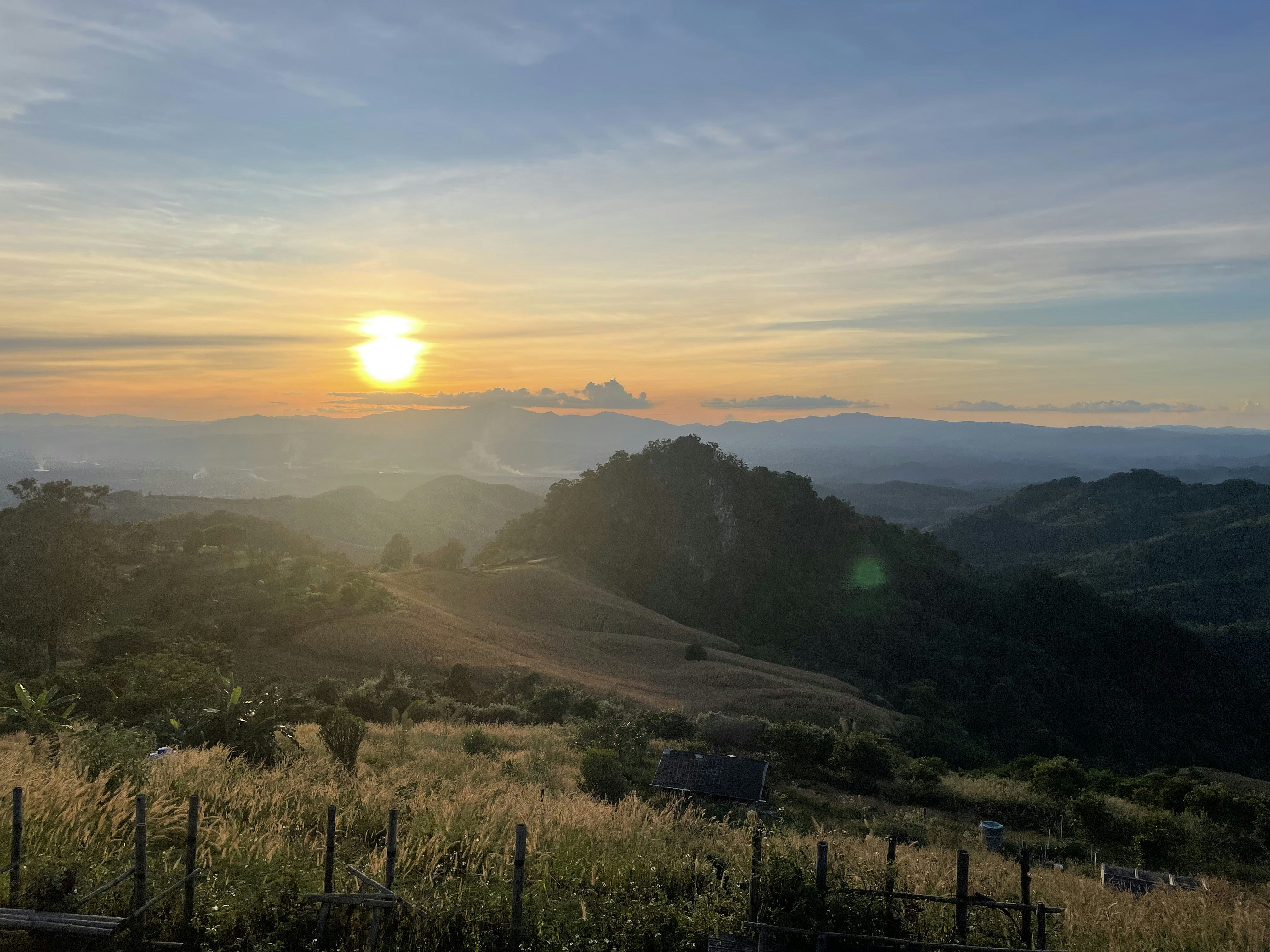Sunrise over rolling hills and lush landscape of Doi Samer Dao, Thailand.