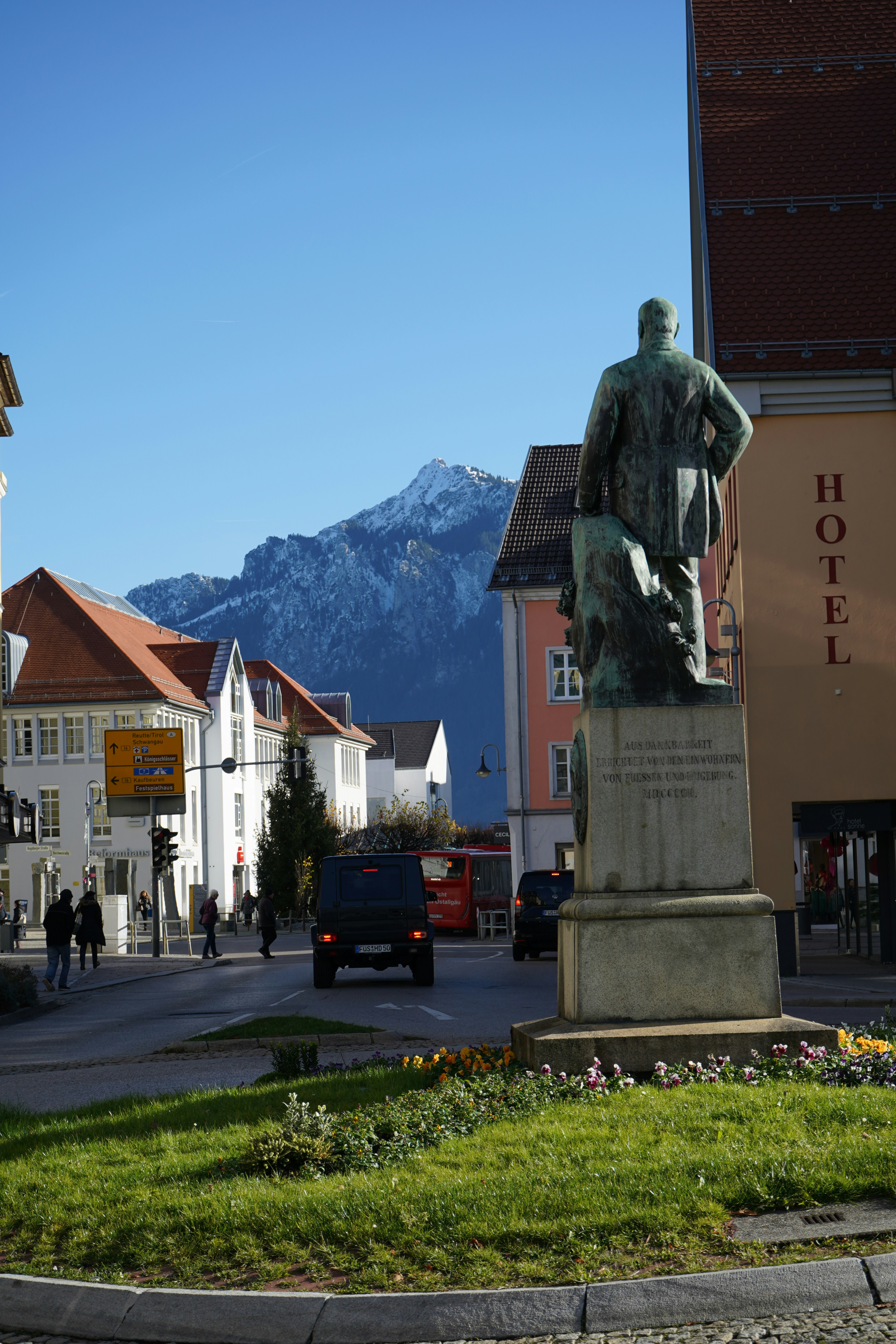 Bronze Sentinel Over a Sunlit Alpine Town
