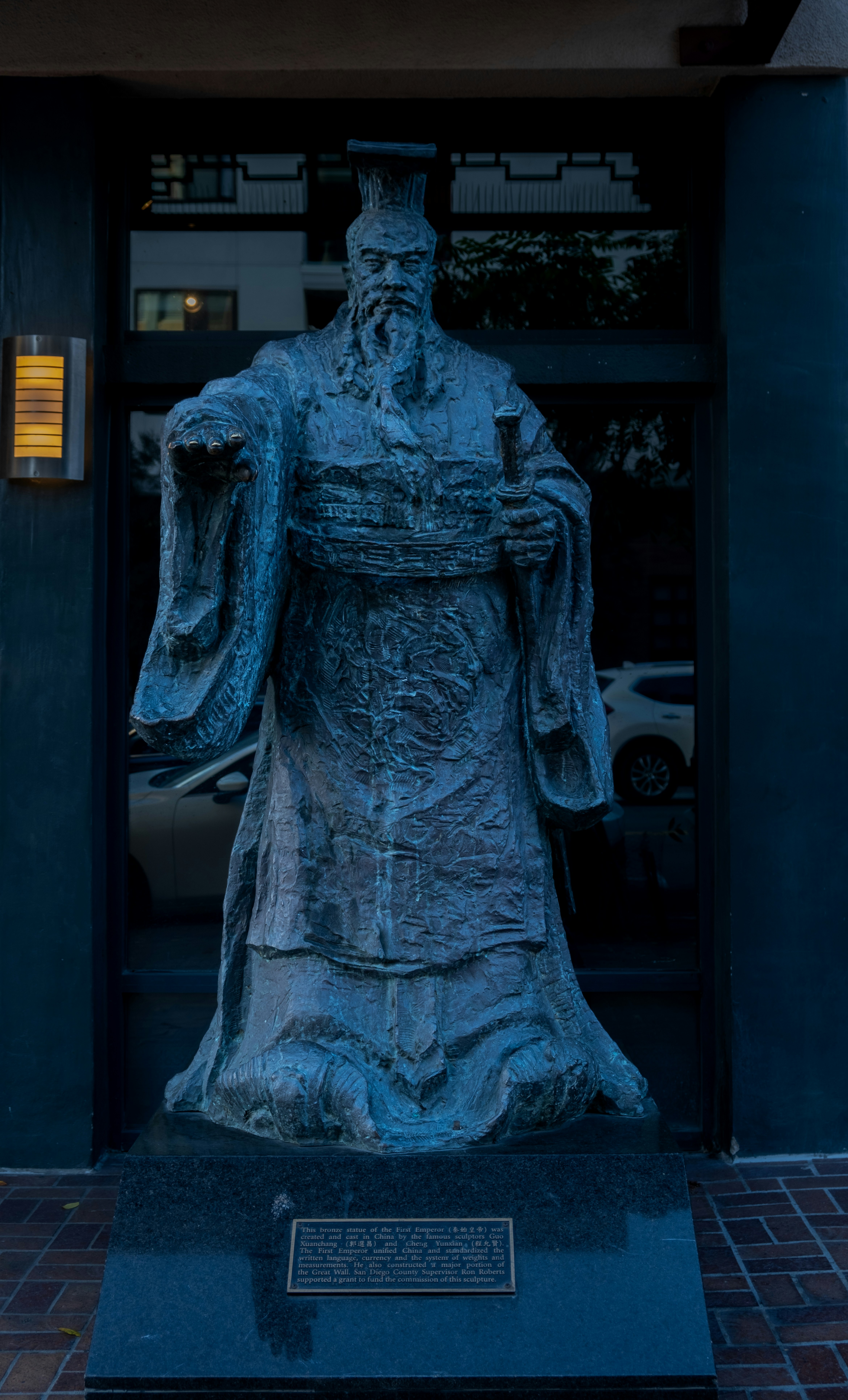 Statue of the Eternal Diplomat: A Blue-Tinted Guardian at Dusk