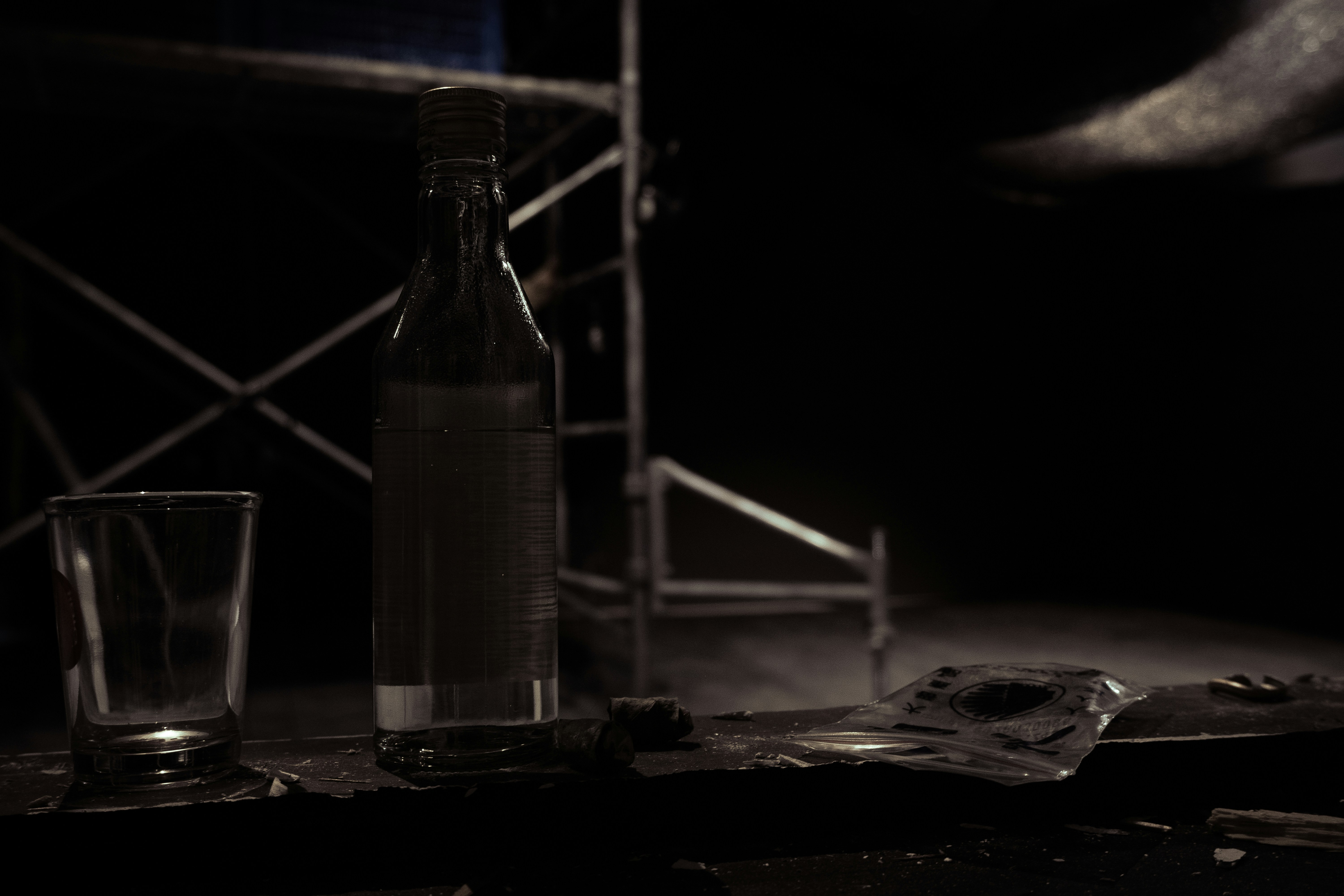 a bottle of water and a glass on a table