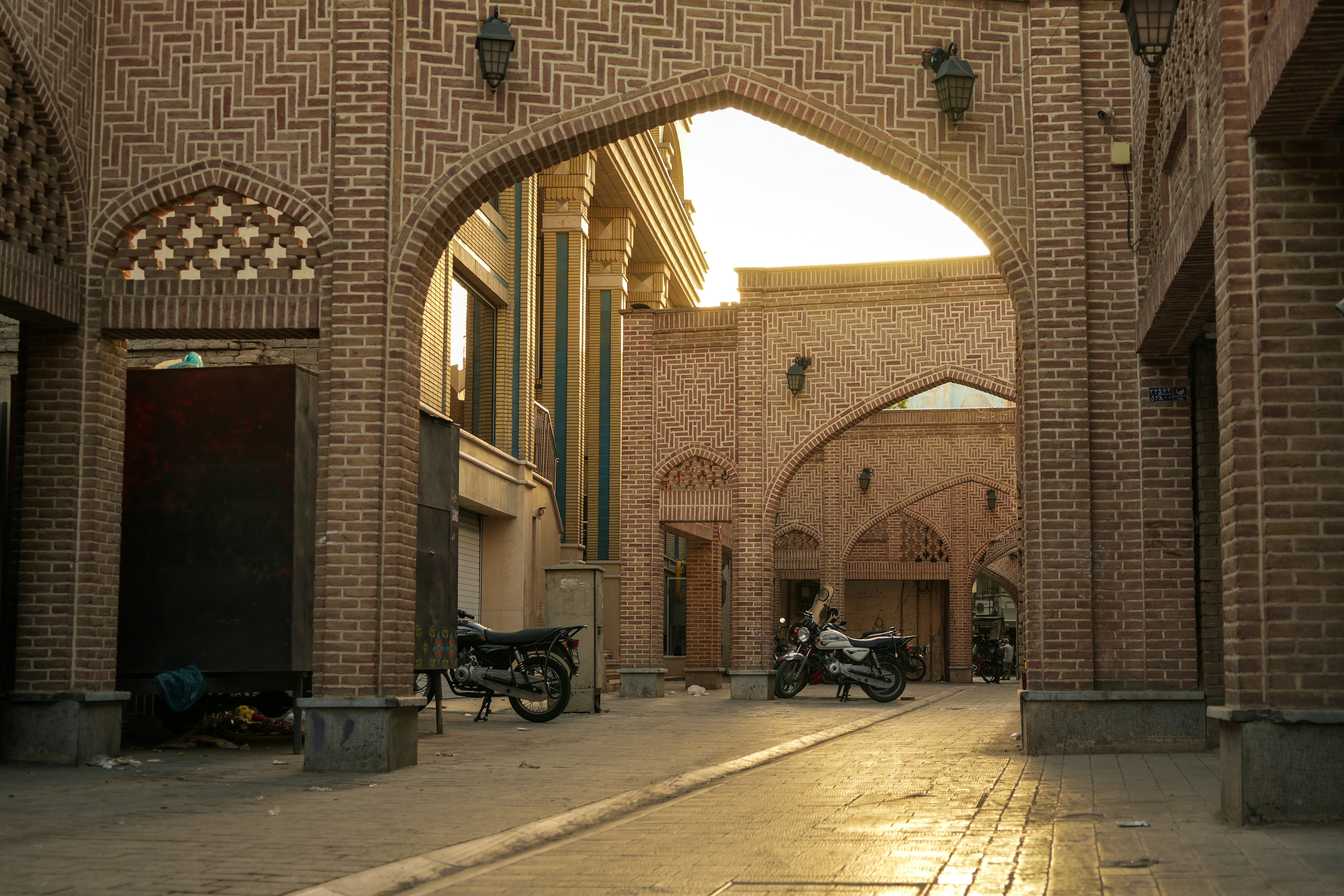A brick building with a motorcycle parked in the front photo – Free ...