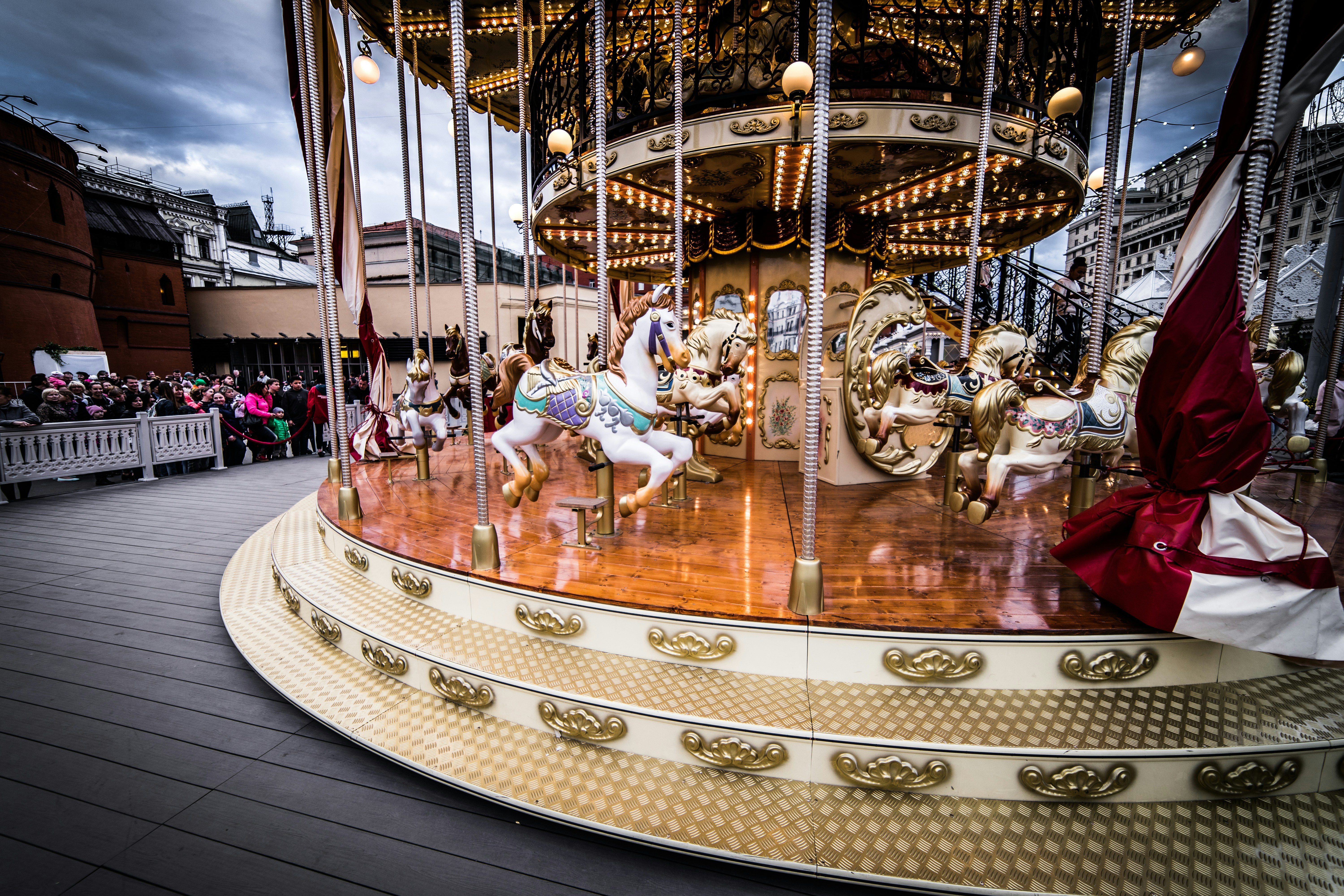 A group of people on a merry go round photo – Free Carousel Image on ...