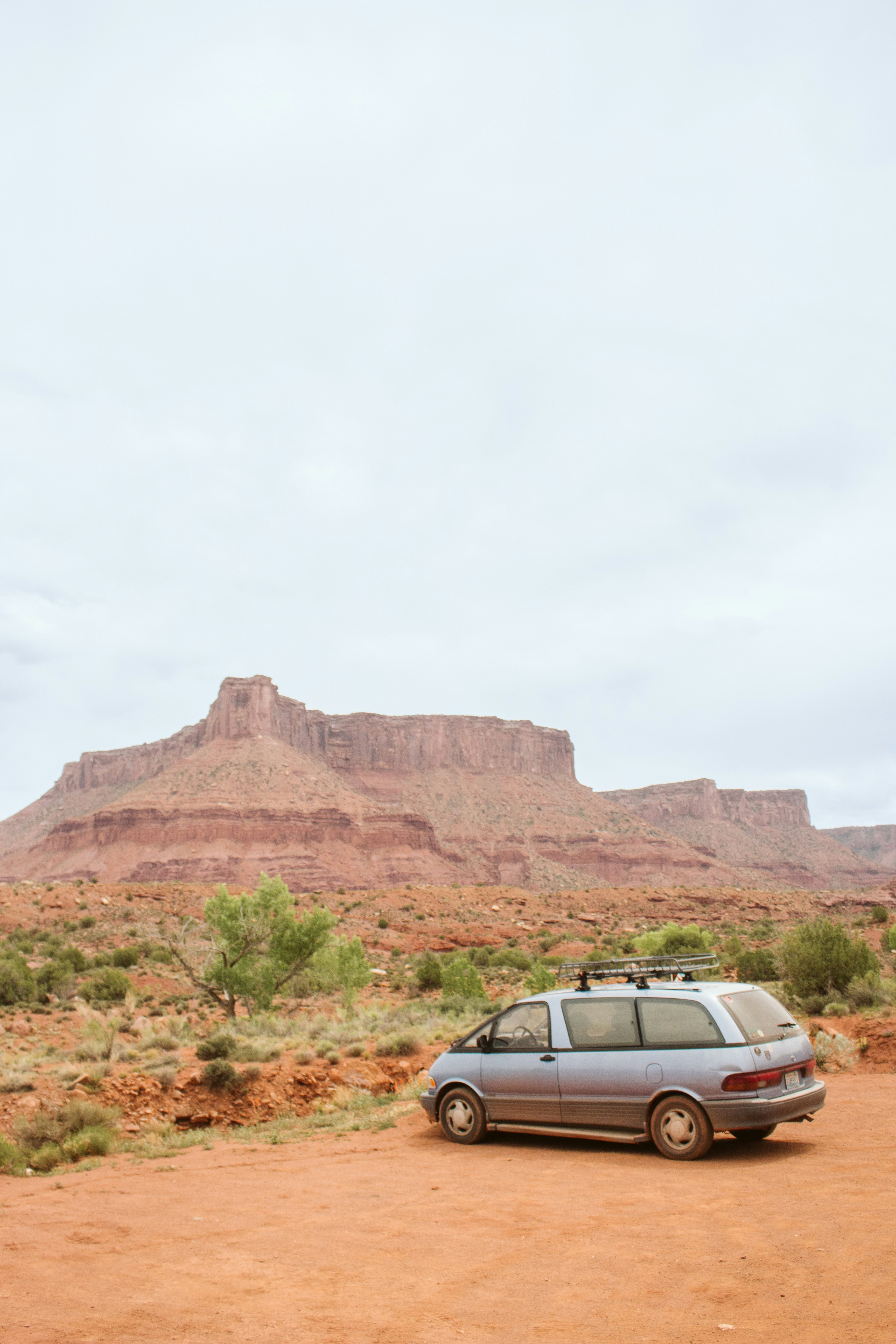 a car parked in front of a rock formation