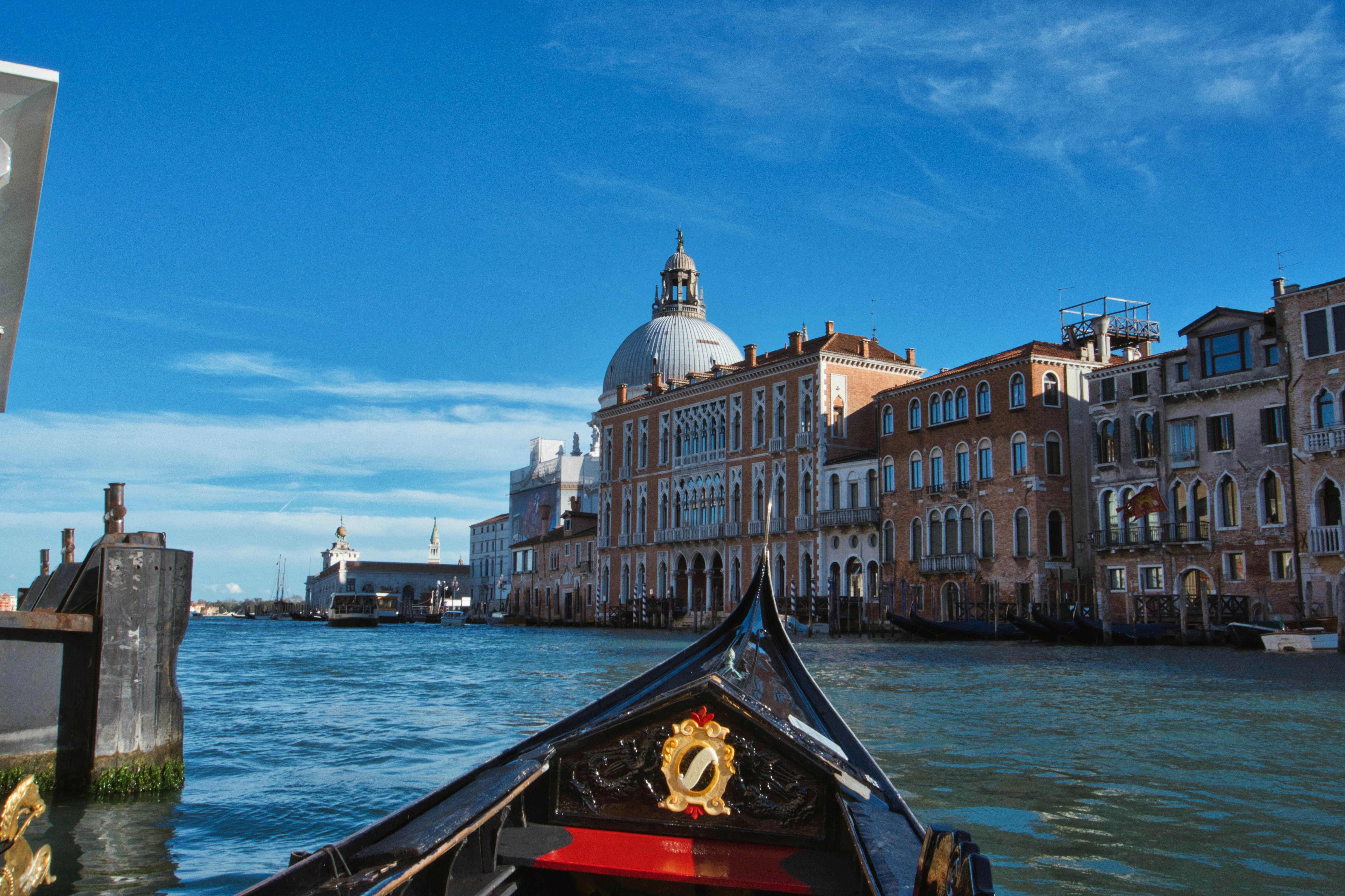 Gondola Bow at the Venetian Canal: Cerulean Sky and Brick Facades