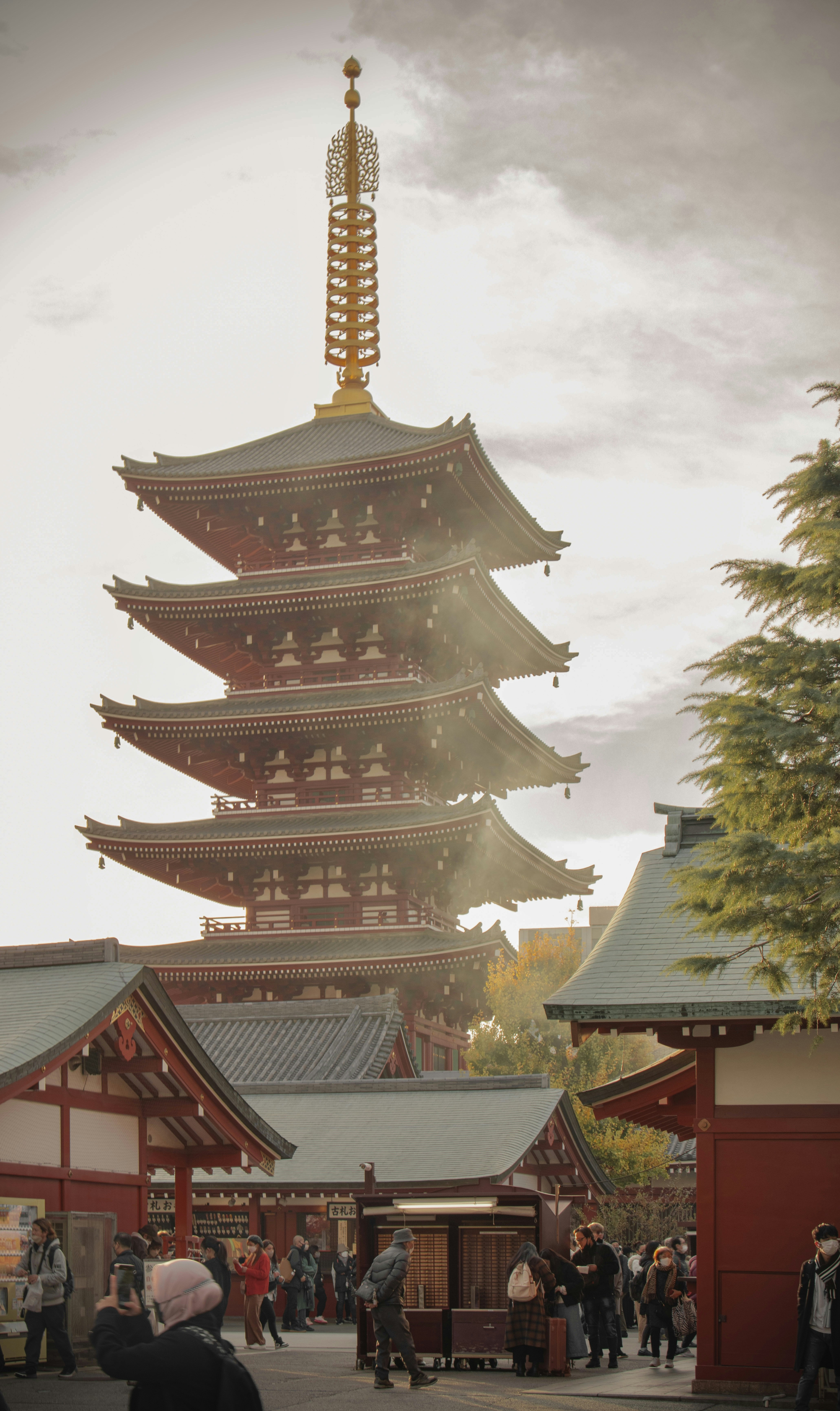 A tall asian building with a gold top photo – Free Building Image on ...
