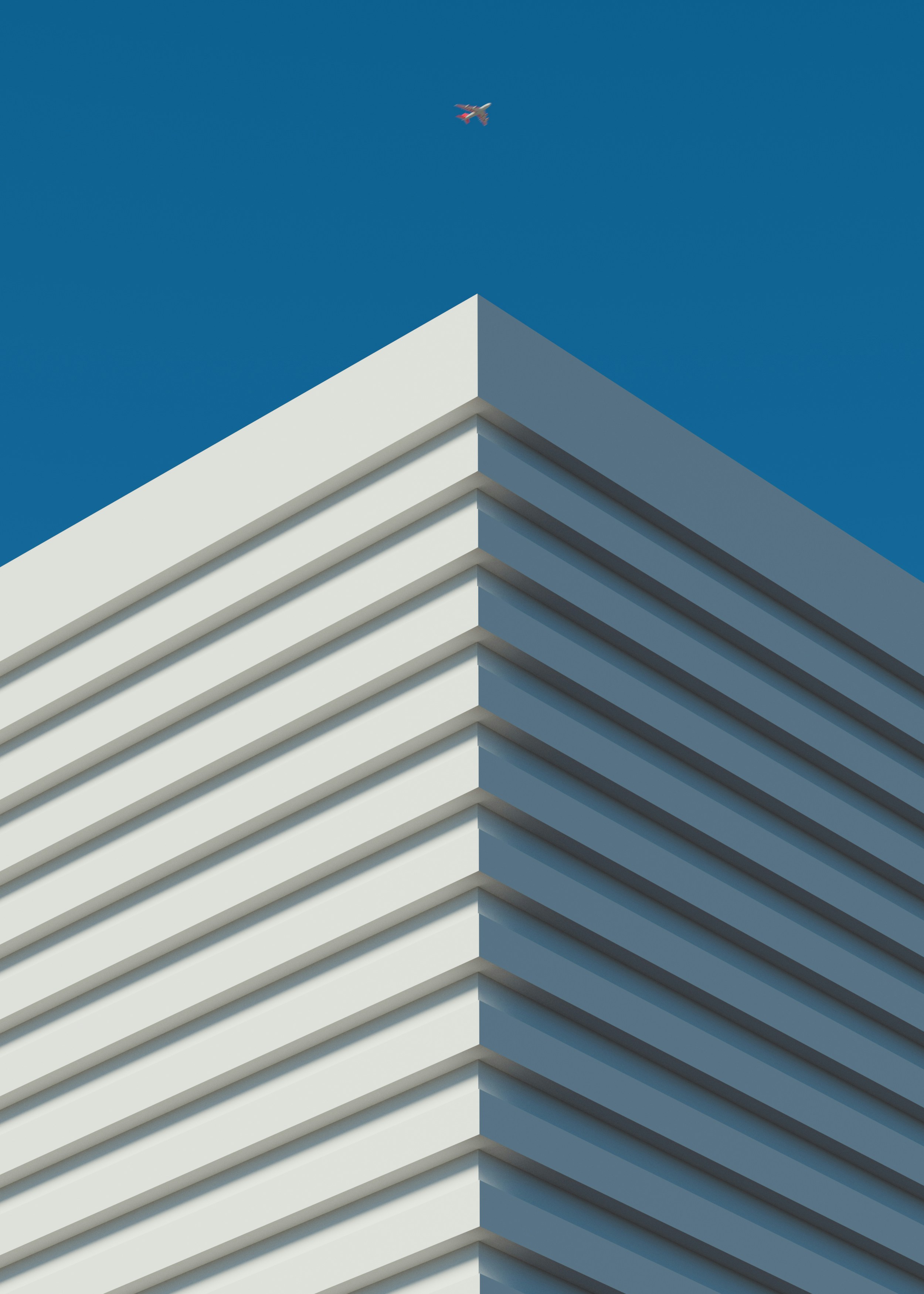 A plane flying over a building photo – Free Texture Image on Unsplash