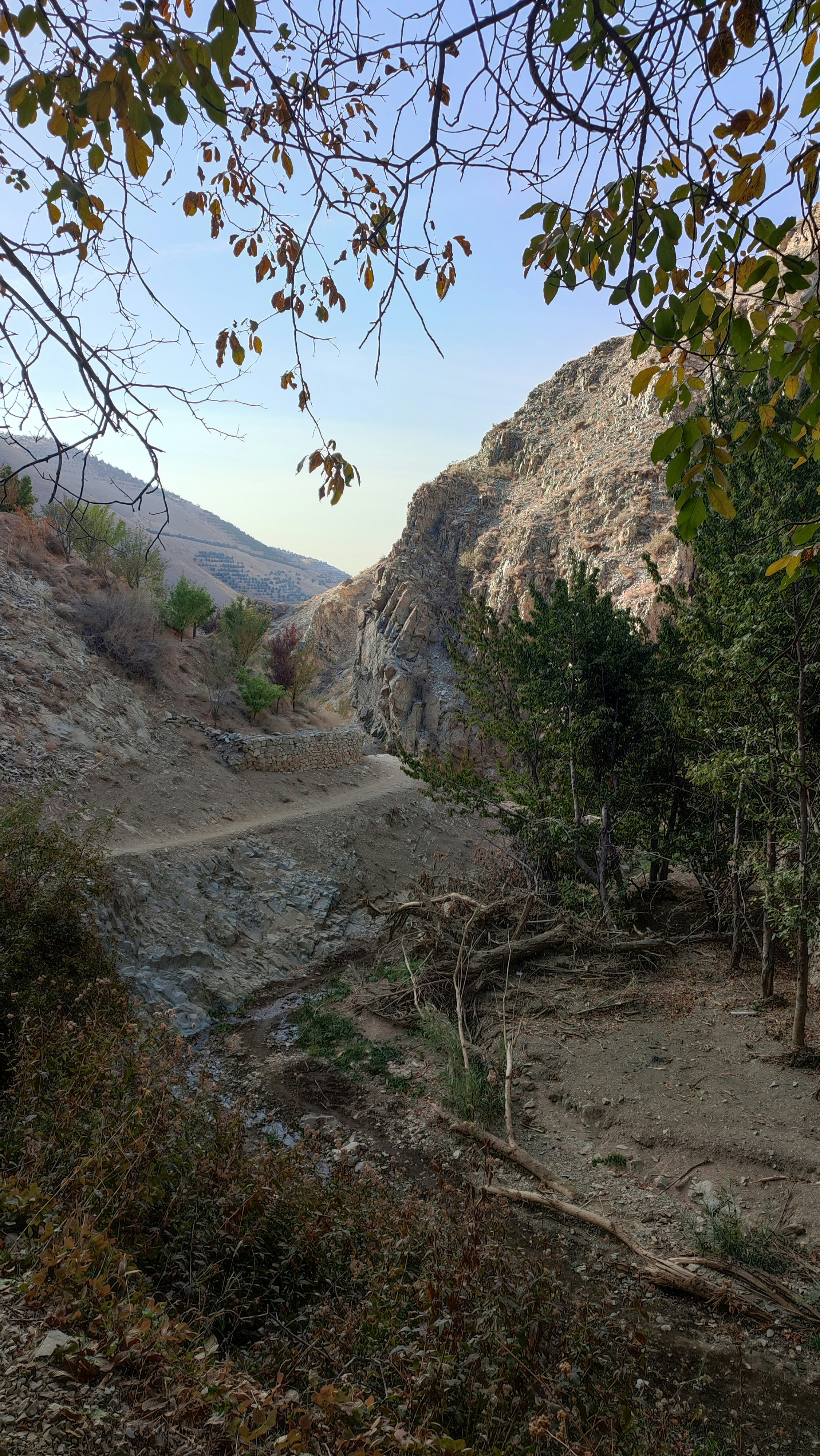 a dirt road going through a mountain