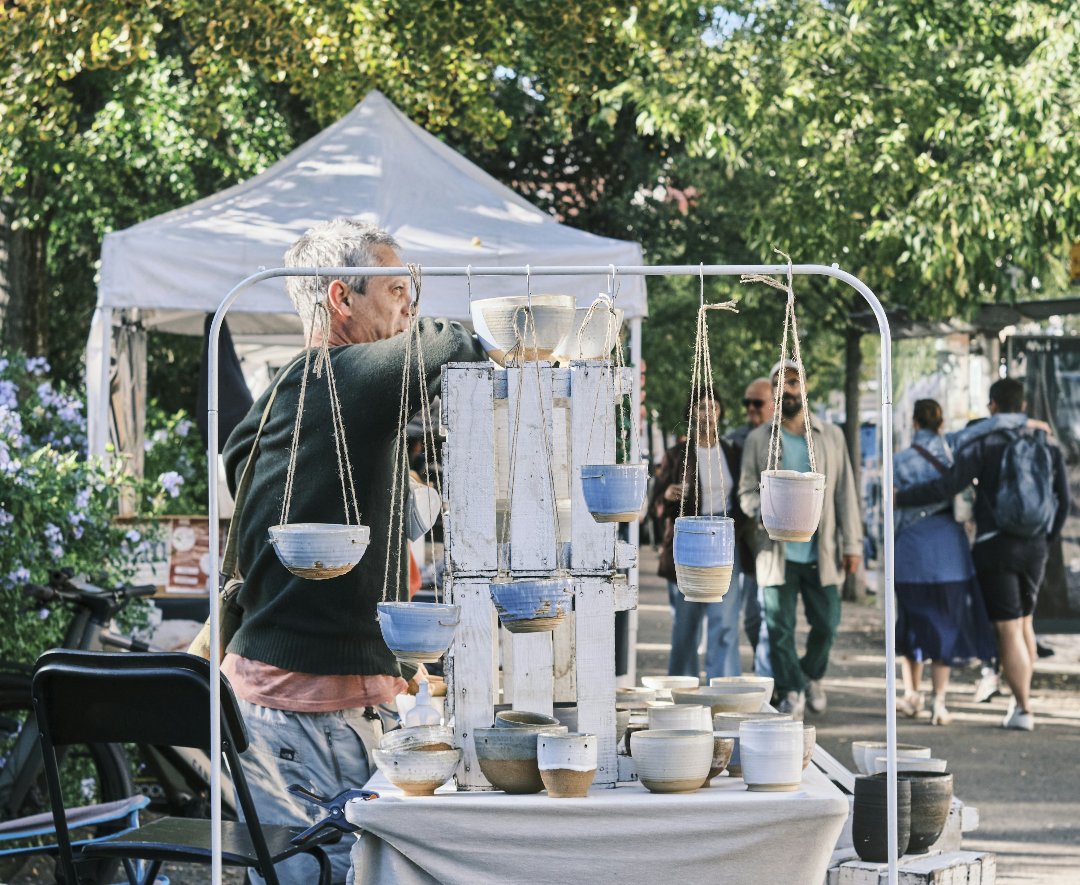 A person selling food at an outdoor market photo – Free People Image on ...