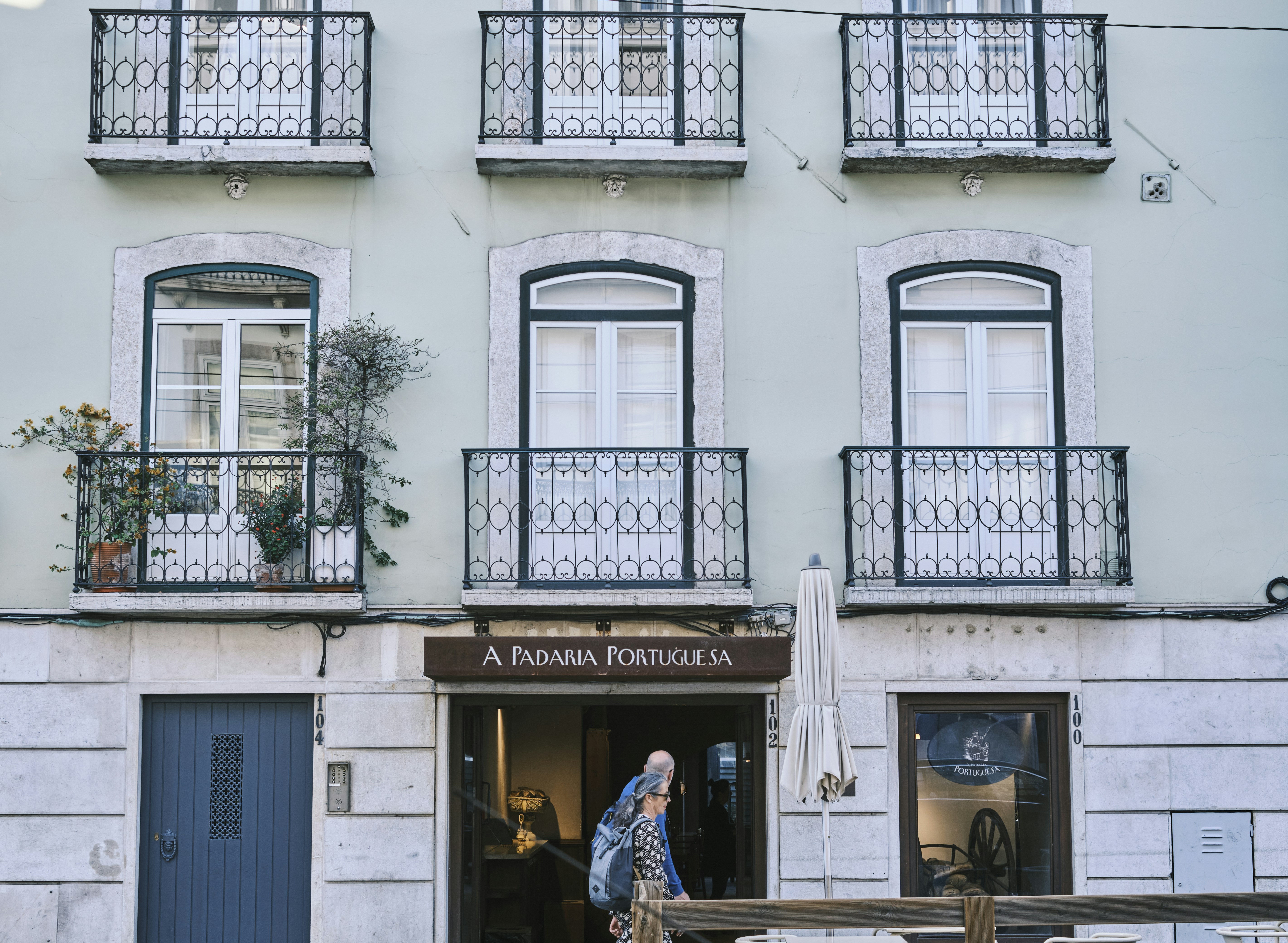 A person walking out of a building photo – Free Window Image on Unsplash