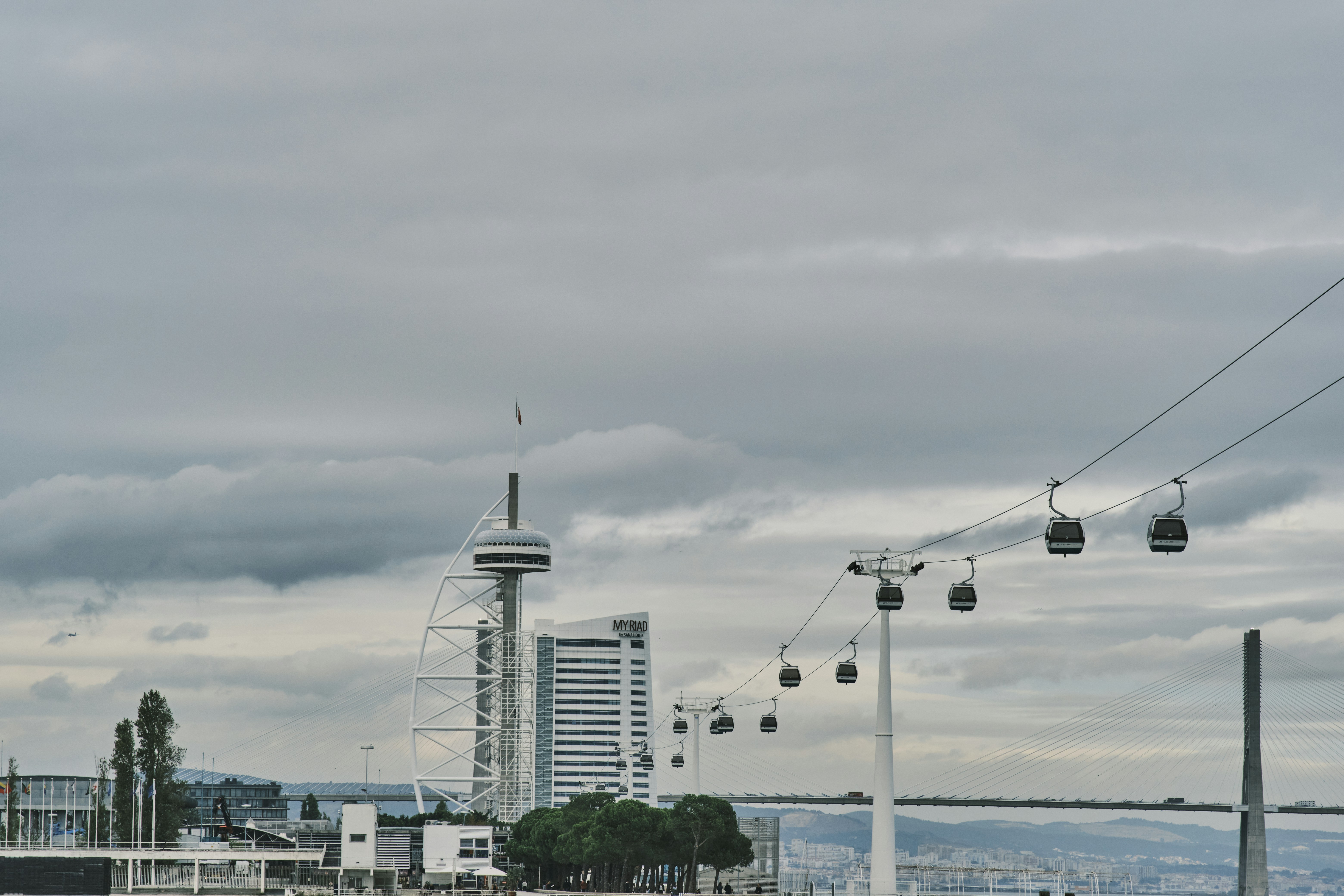 Gondola Arc Over a Cloudy Skyline, with the Round-Top Tower as Anchor