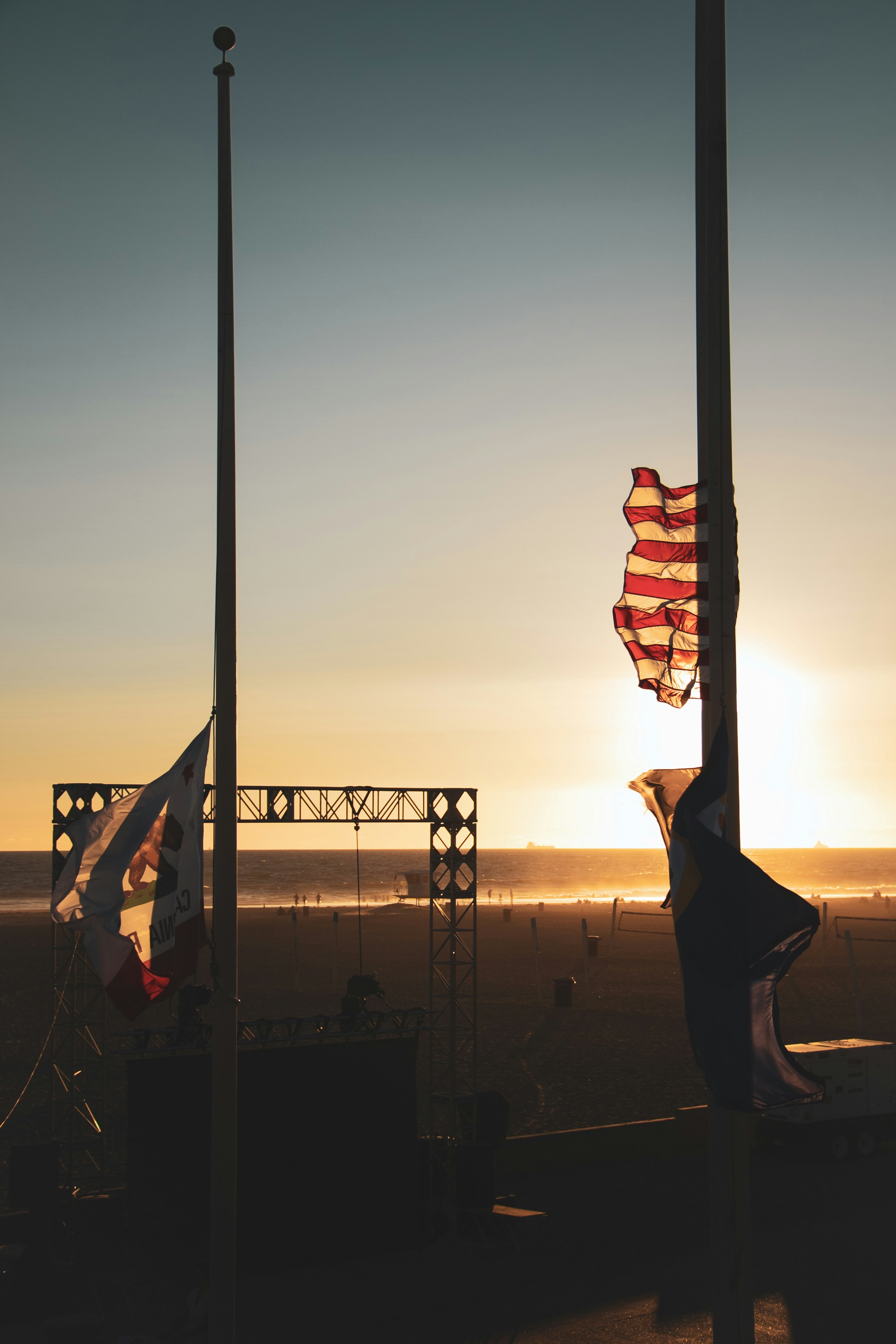 U.S. and California flags during a sunset in California, Huntington Beach