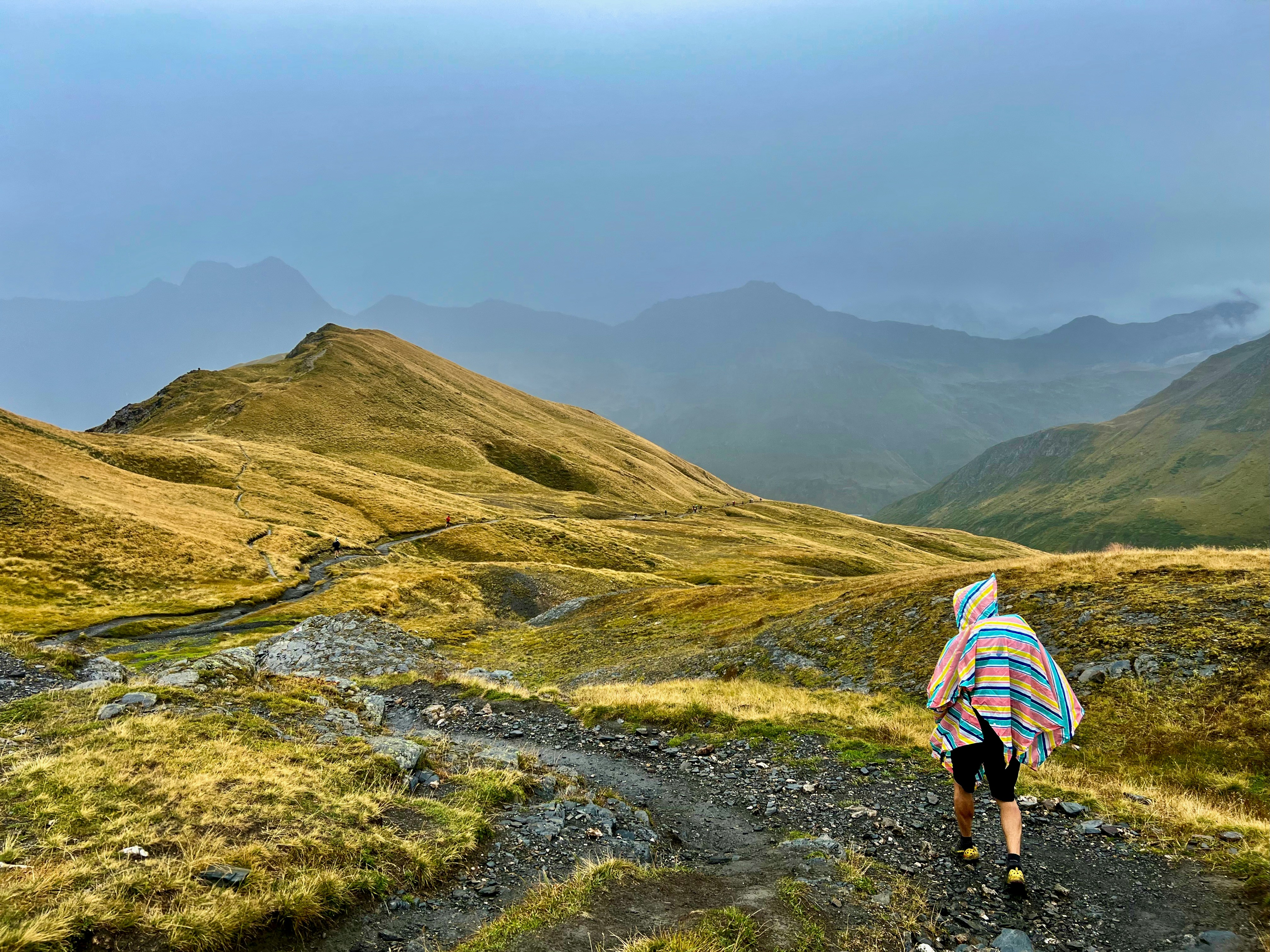 A person walking on a path with an umbrella photo – Free Mountains ...