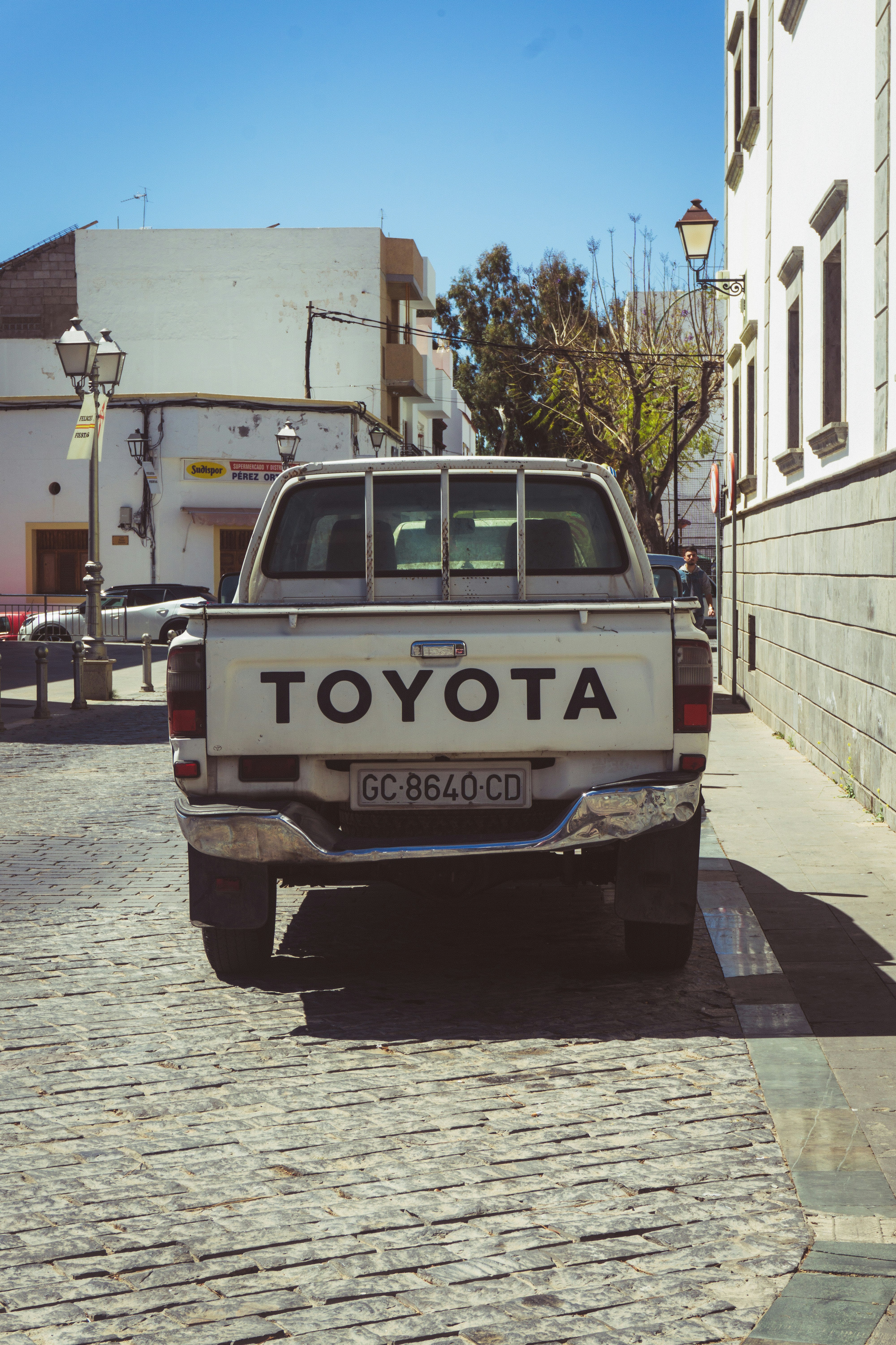 Rear View Toyota on a Sunlit Cobblestone Street