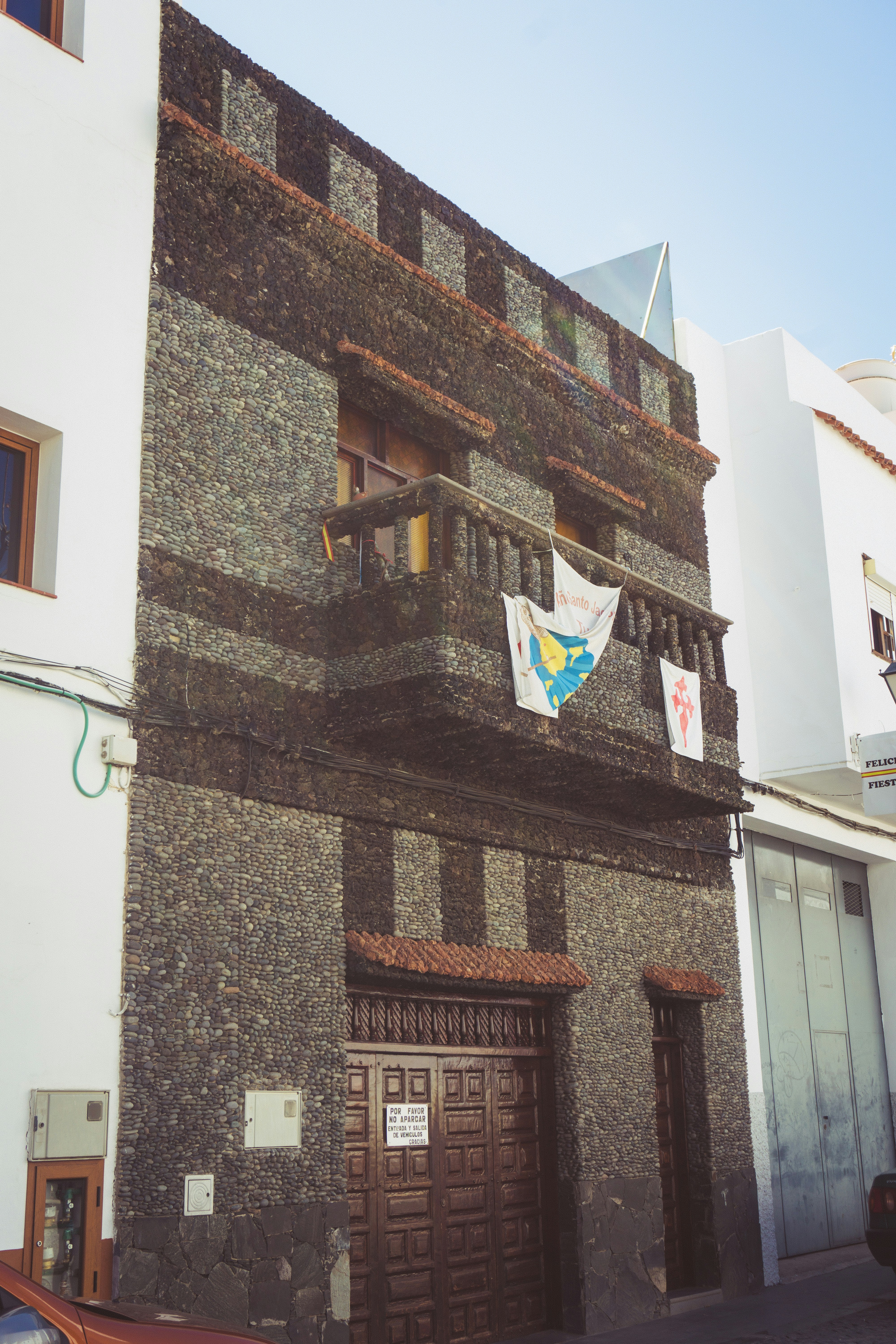 A brick building with flags on it photo – Free Gran canaria Image on ...