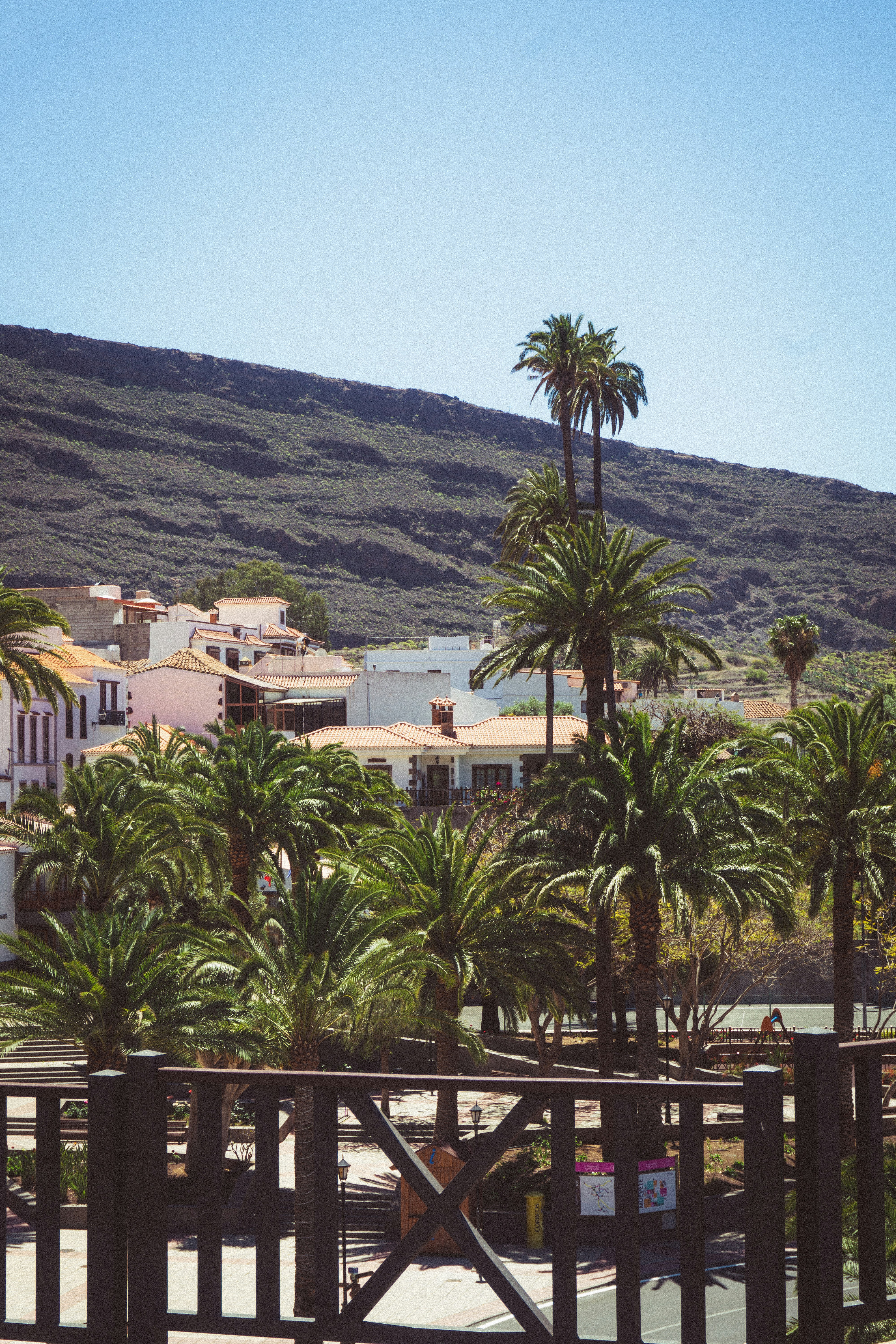 Palm-Crowned Village Beneath a Powder-Blue Sky