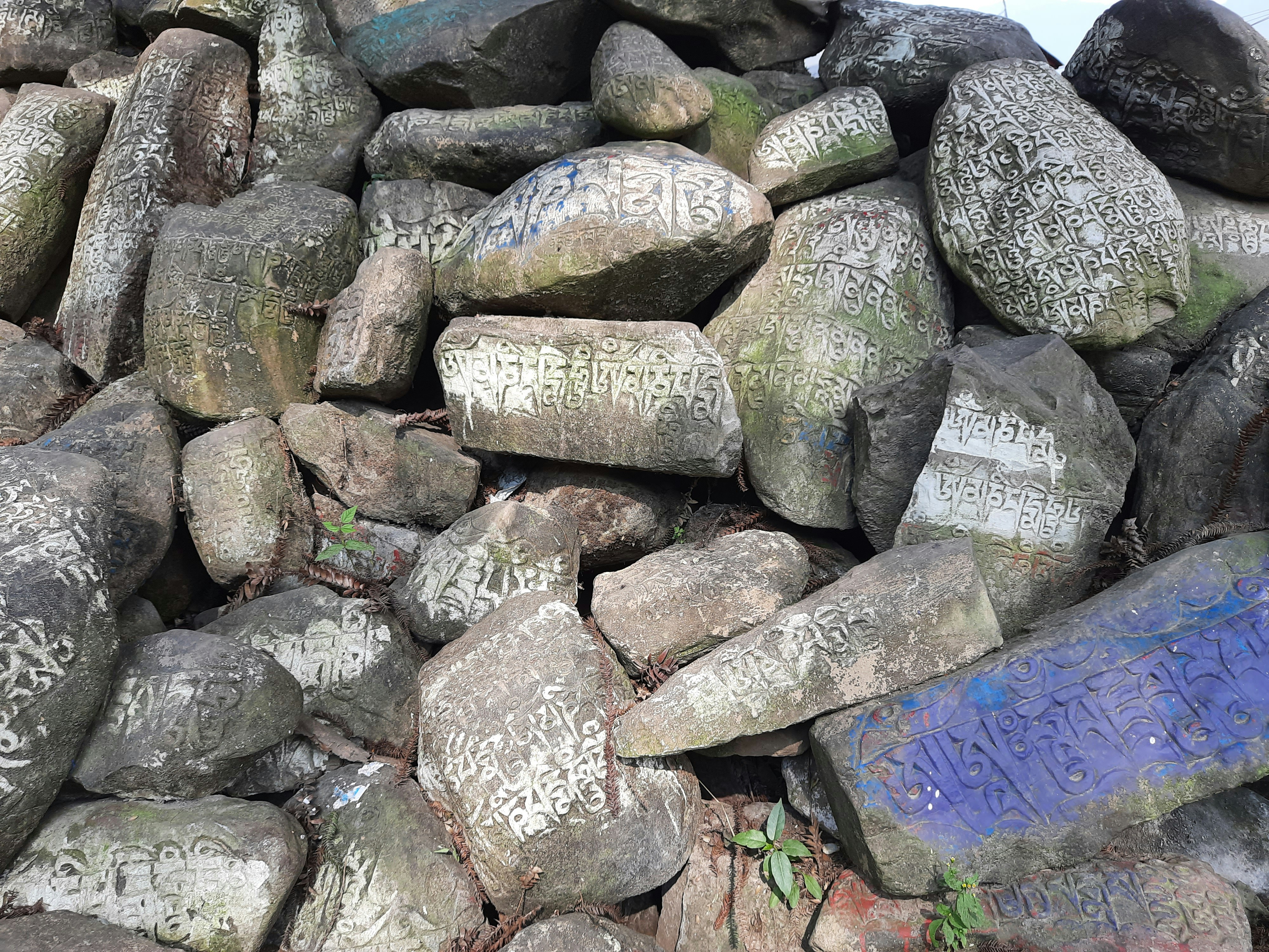 Worn Stones bearing ancient scripts: a mosaic of carved talismans