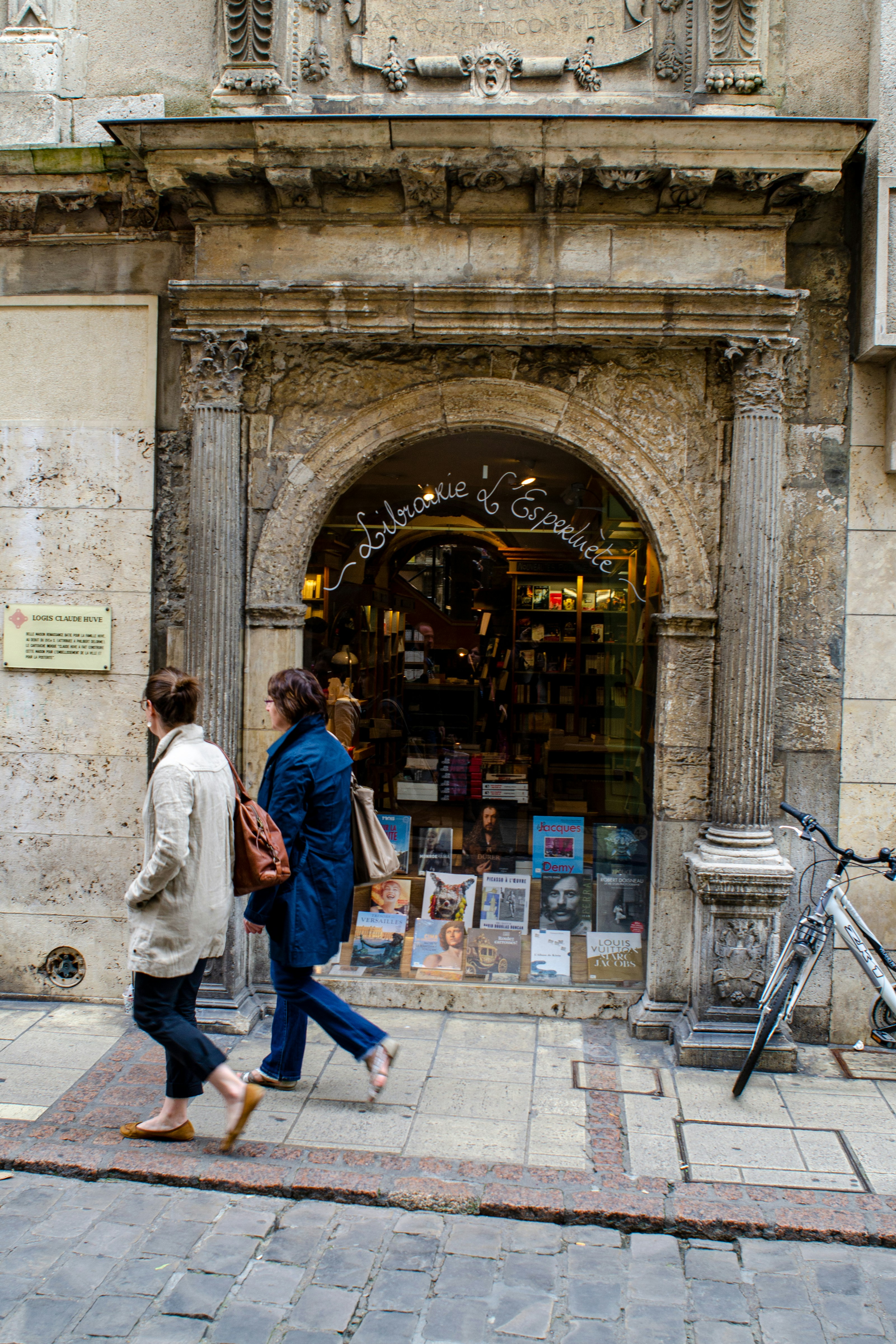 A couple of women walking by a storefront photo – Free Chartres Image ...
