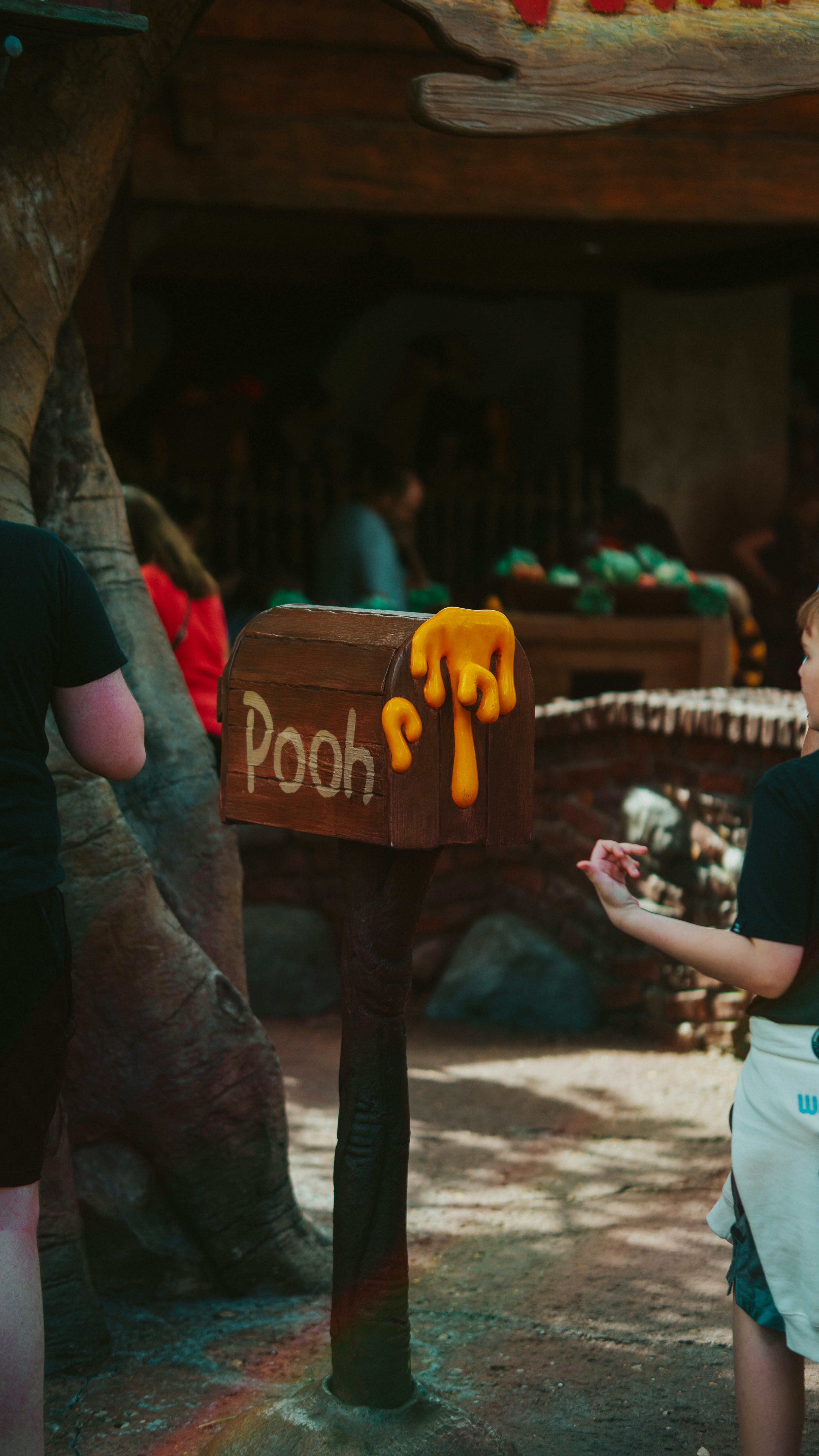 Pooh's Honey Stop: A Weathered Mailbox in a Theme Park Scene