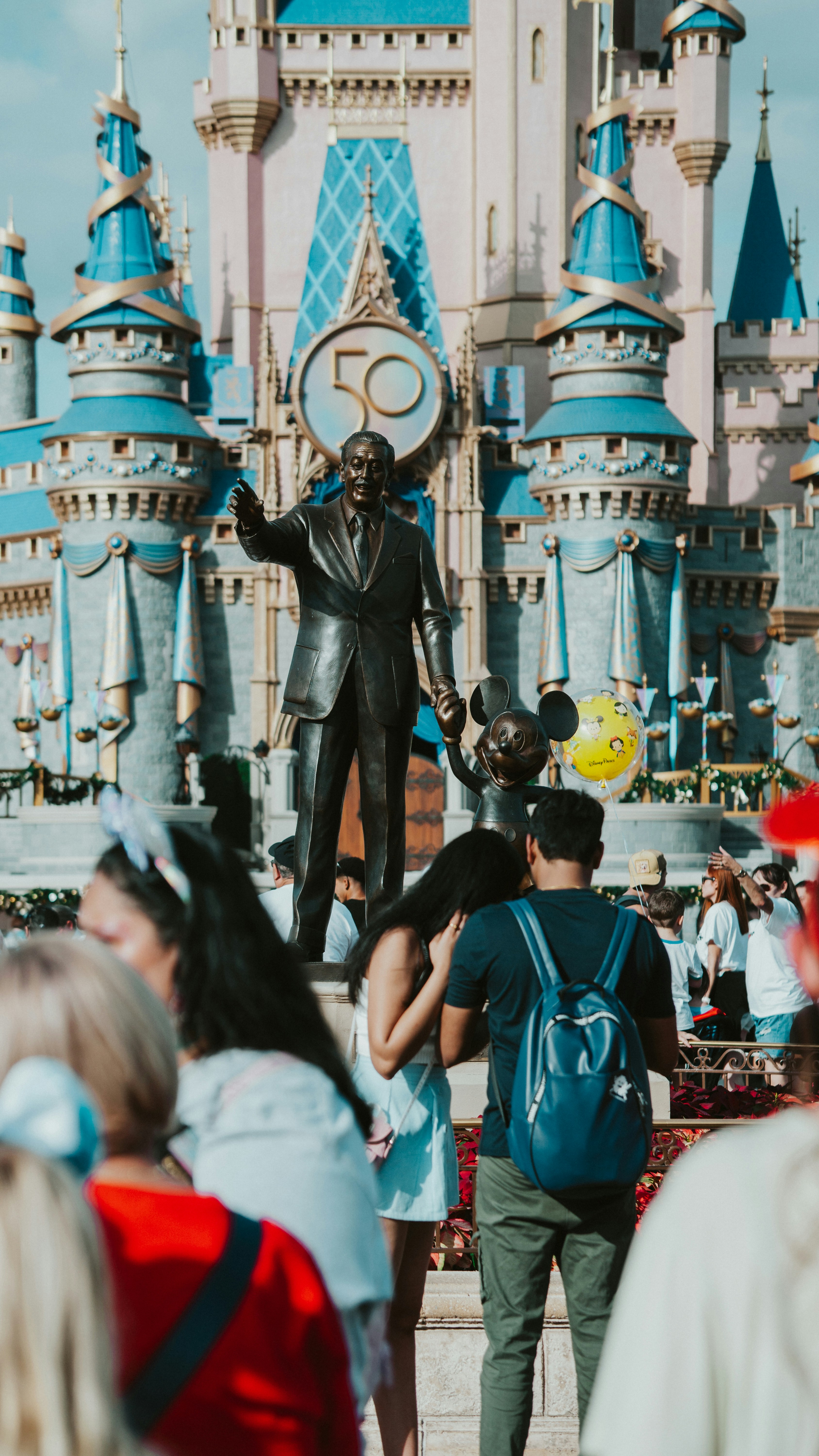 A statue of a person in front of a crowd of people photo – Free Disney ...