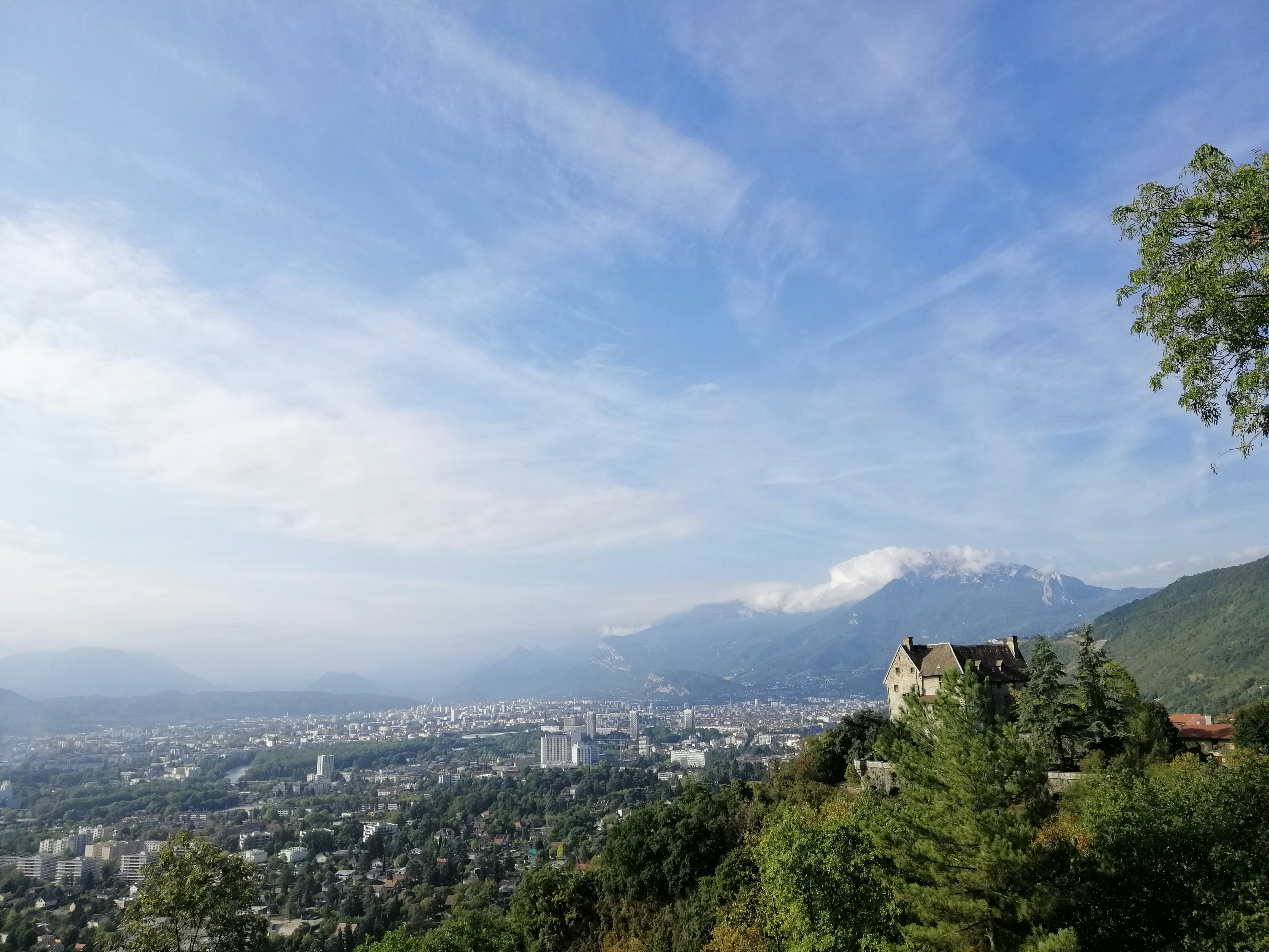Nature and Mountain in Grenoble | a city with trees and mountains in the background
