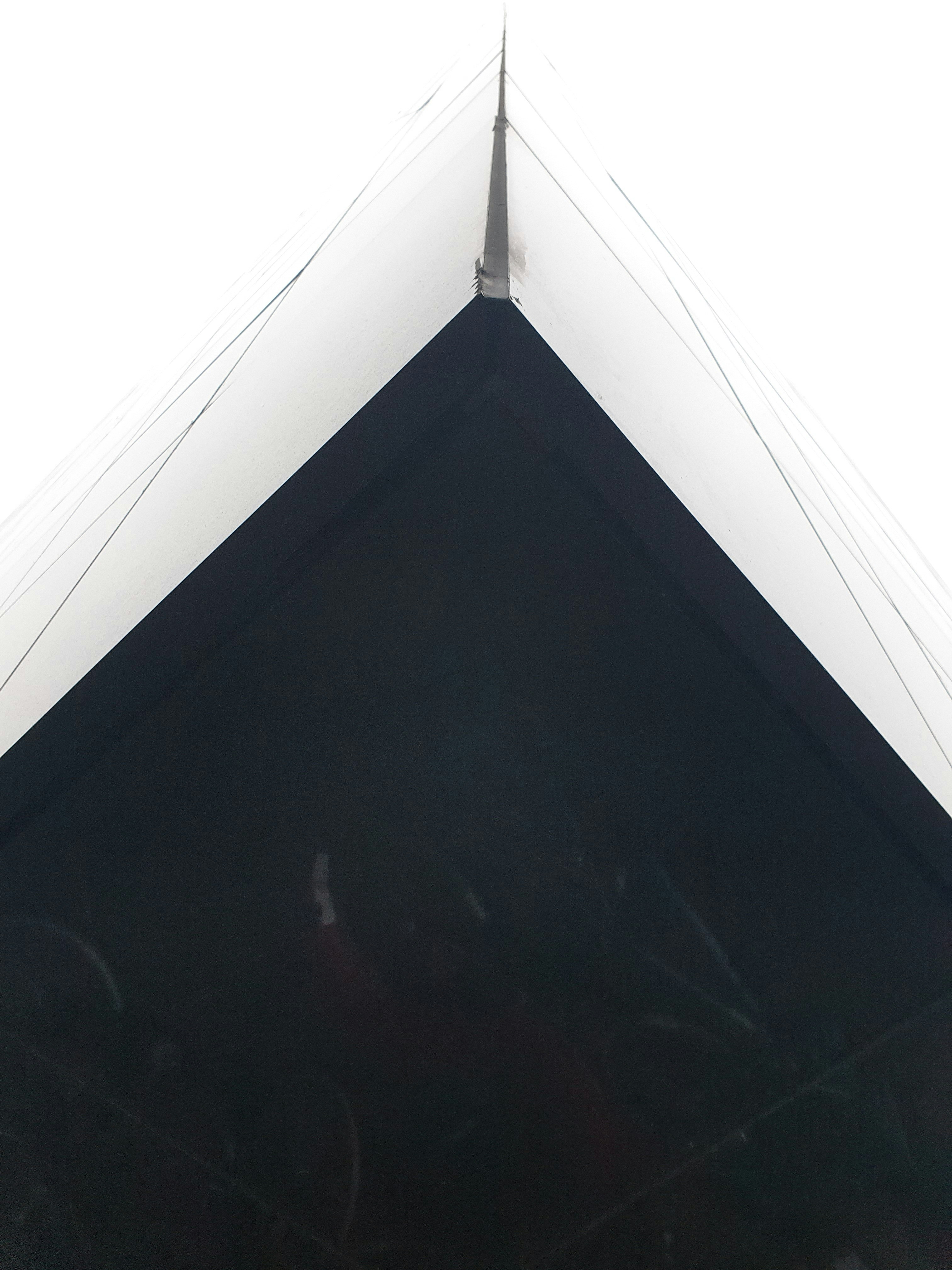 Unique architectural detail showcasing the sharp angles and lines of a modern structure against a bright sky.