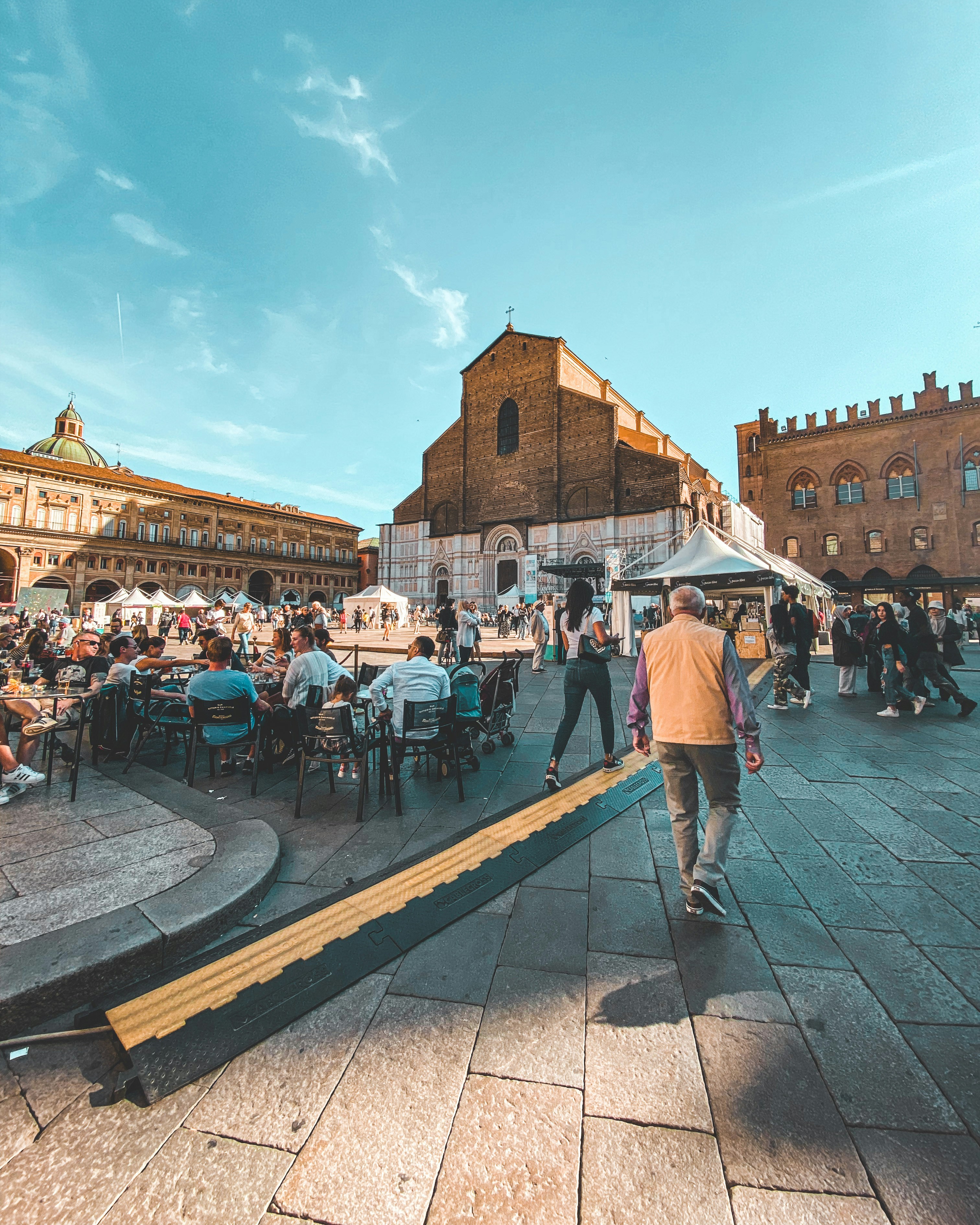 Sunlit Piazza Portrait: A Historic Square Amid Busy Café Tables