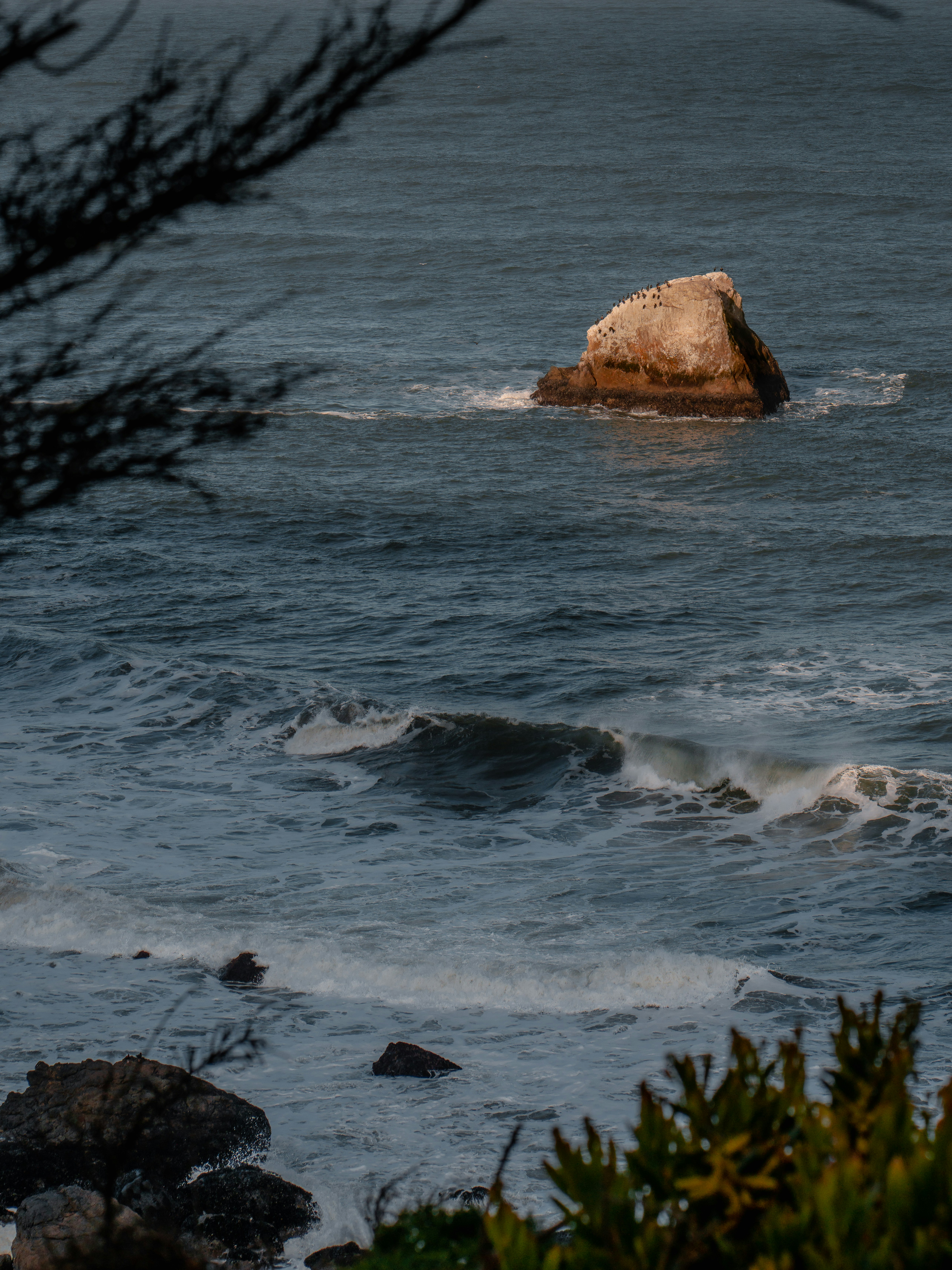 a body of water with rocks and trees around itKellen Riggin