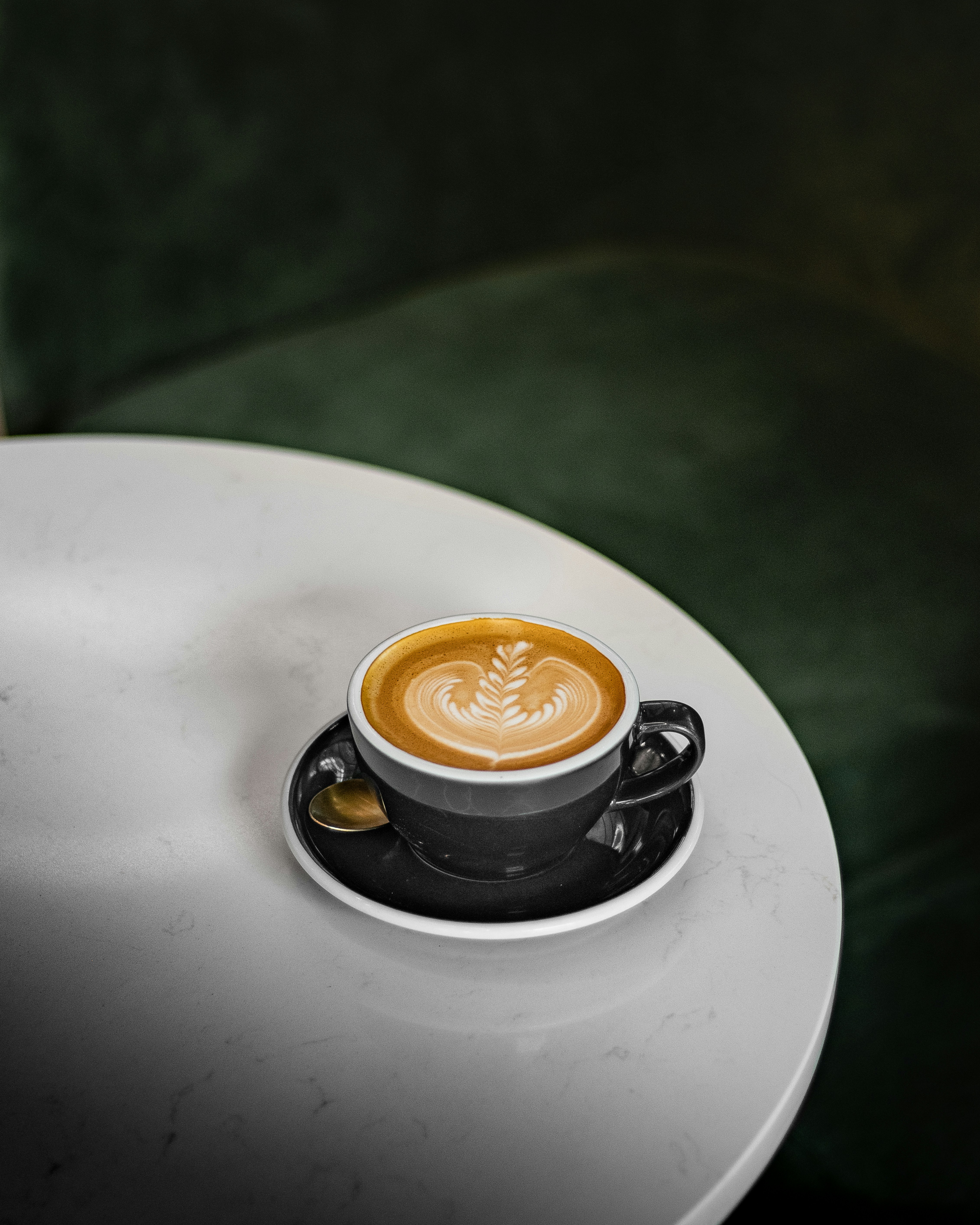 Latte Art on a White Marble Table: Quiet Outdoor Café Moment
