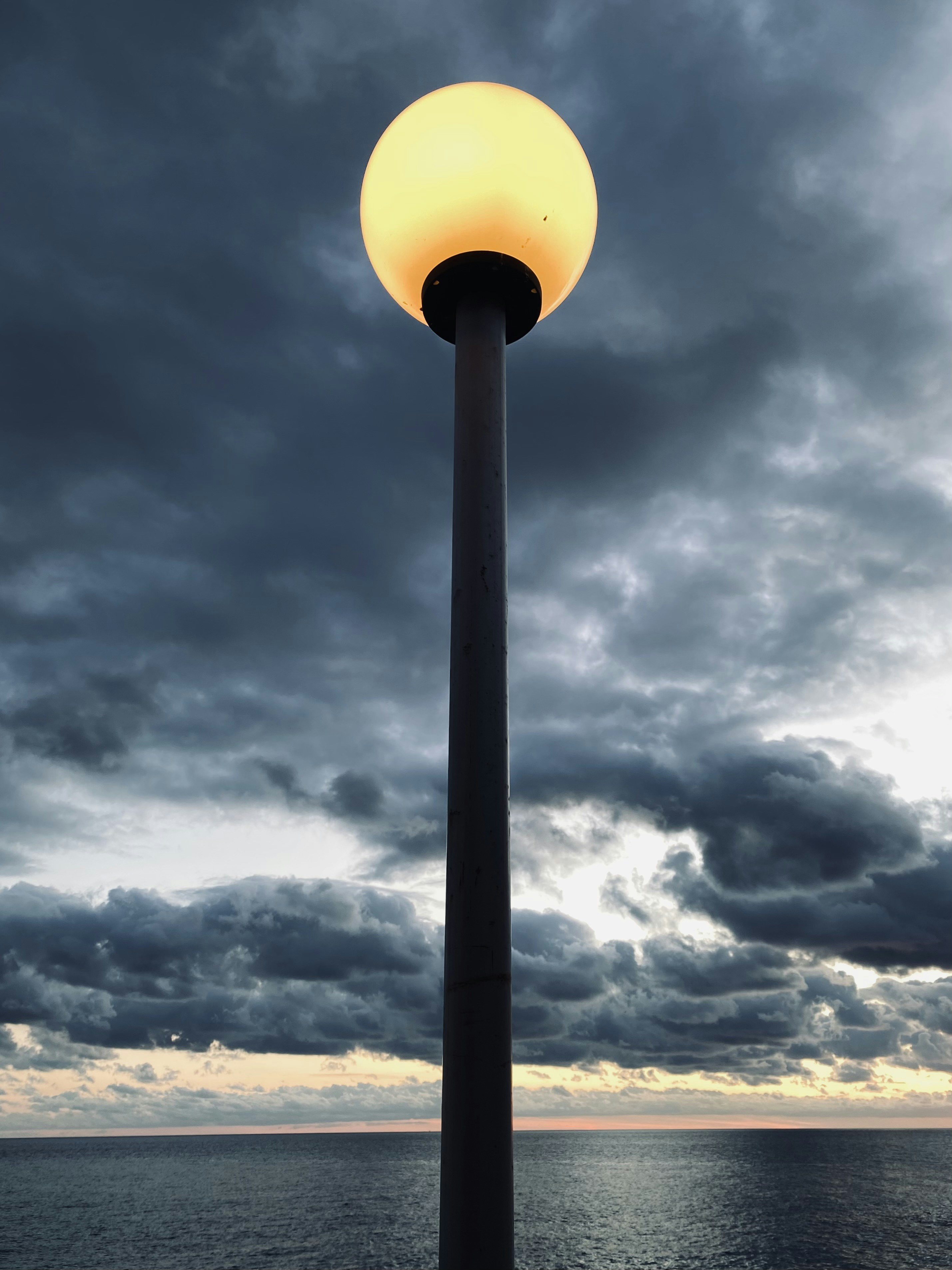 a light post with a yellow ball on top of it