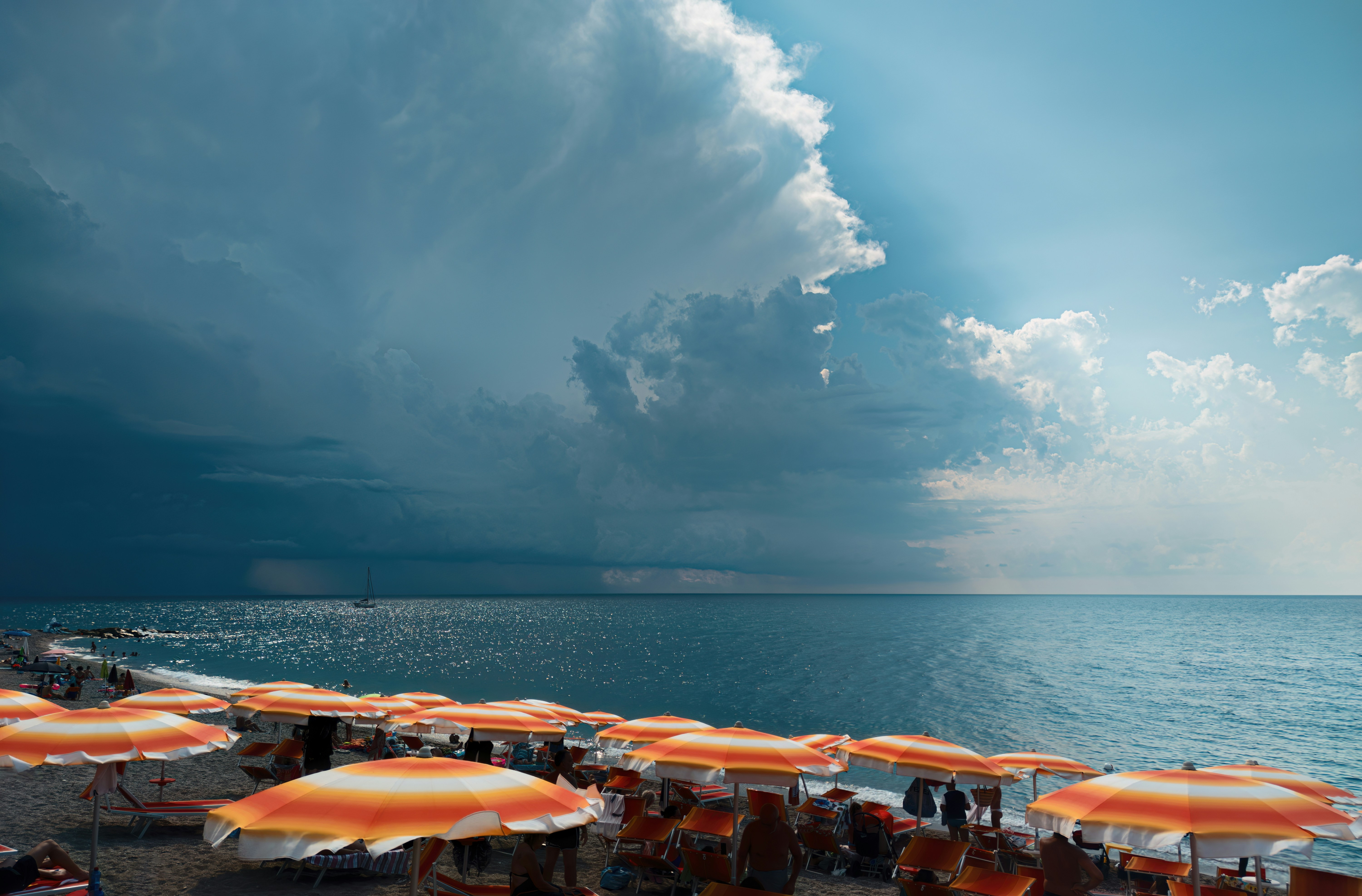 Sunlit Beach Umbrellas Under a Looming Thunderhead