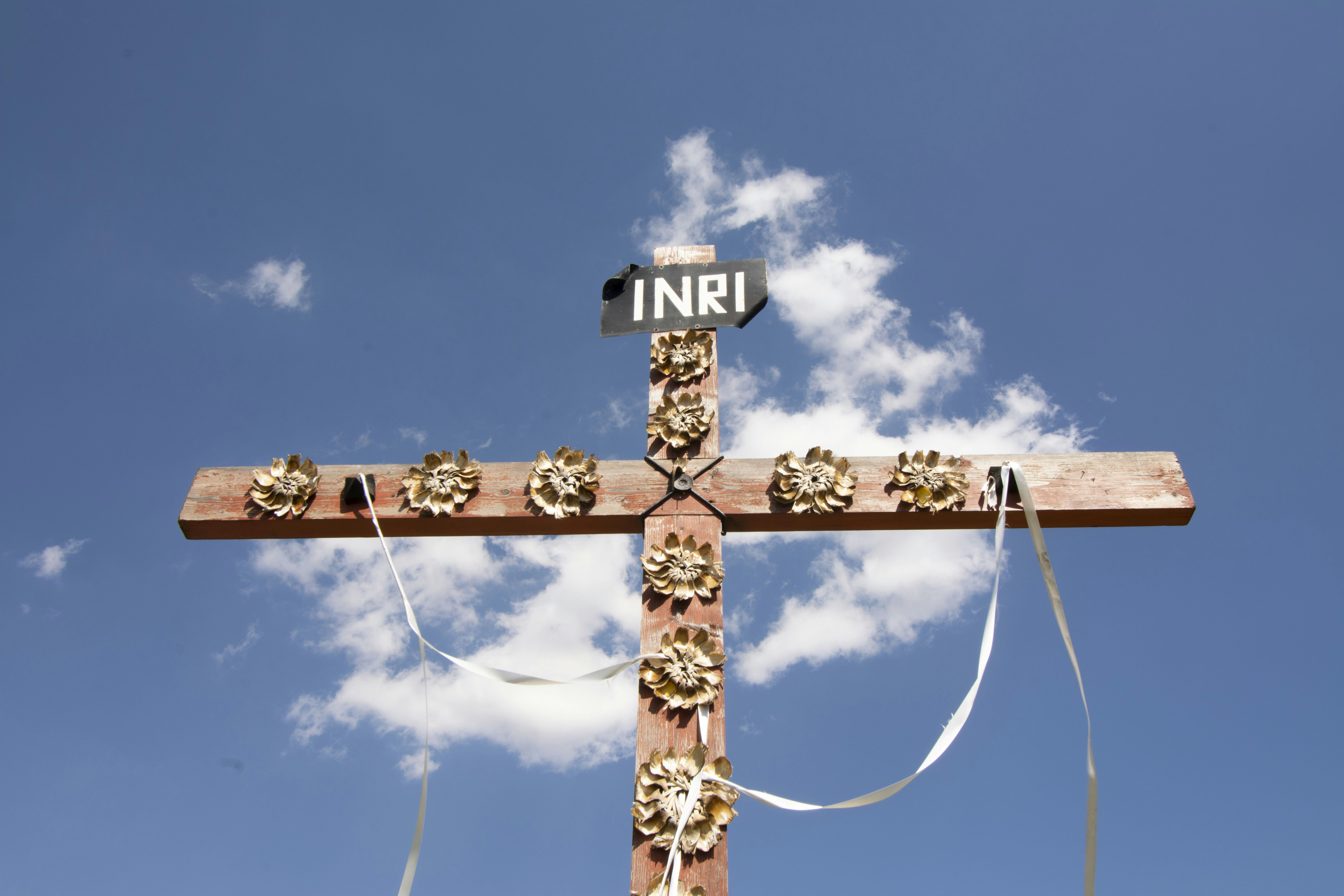 Un letrero de la calle con una cruz en la parte superior foto – Imagen ...