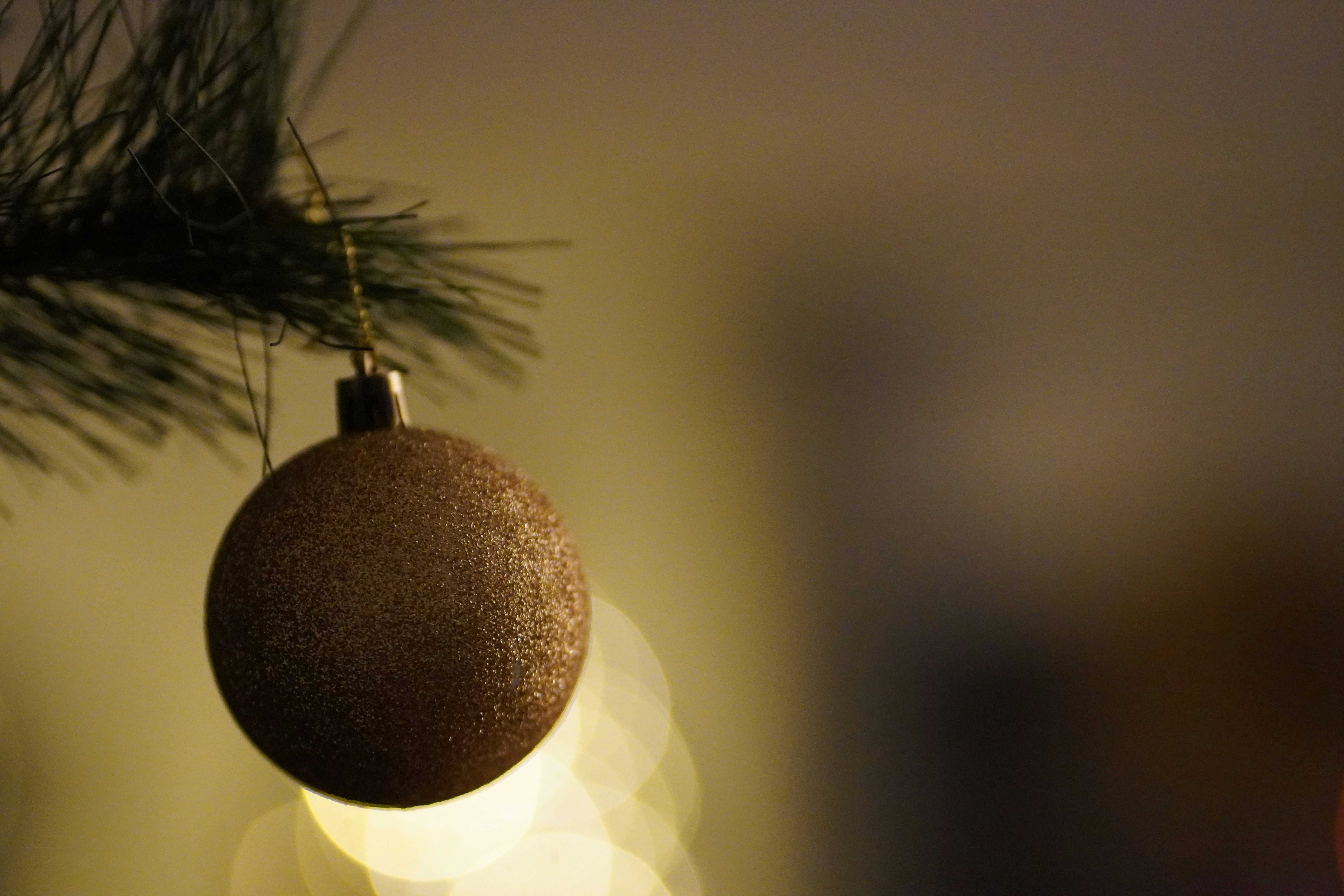 a round brown object with a black object on top of it