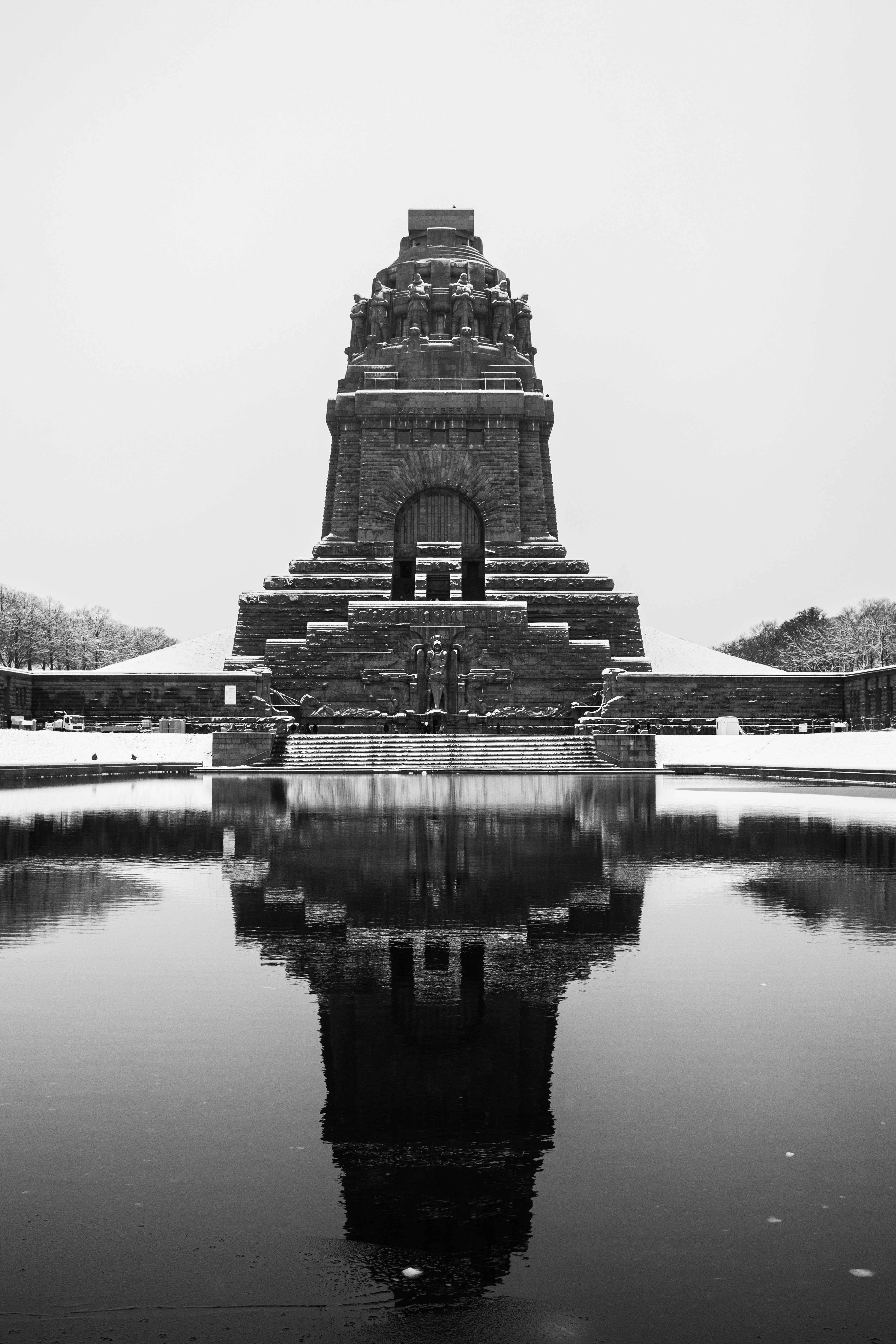 a large tower with a bridge over water